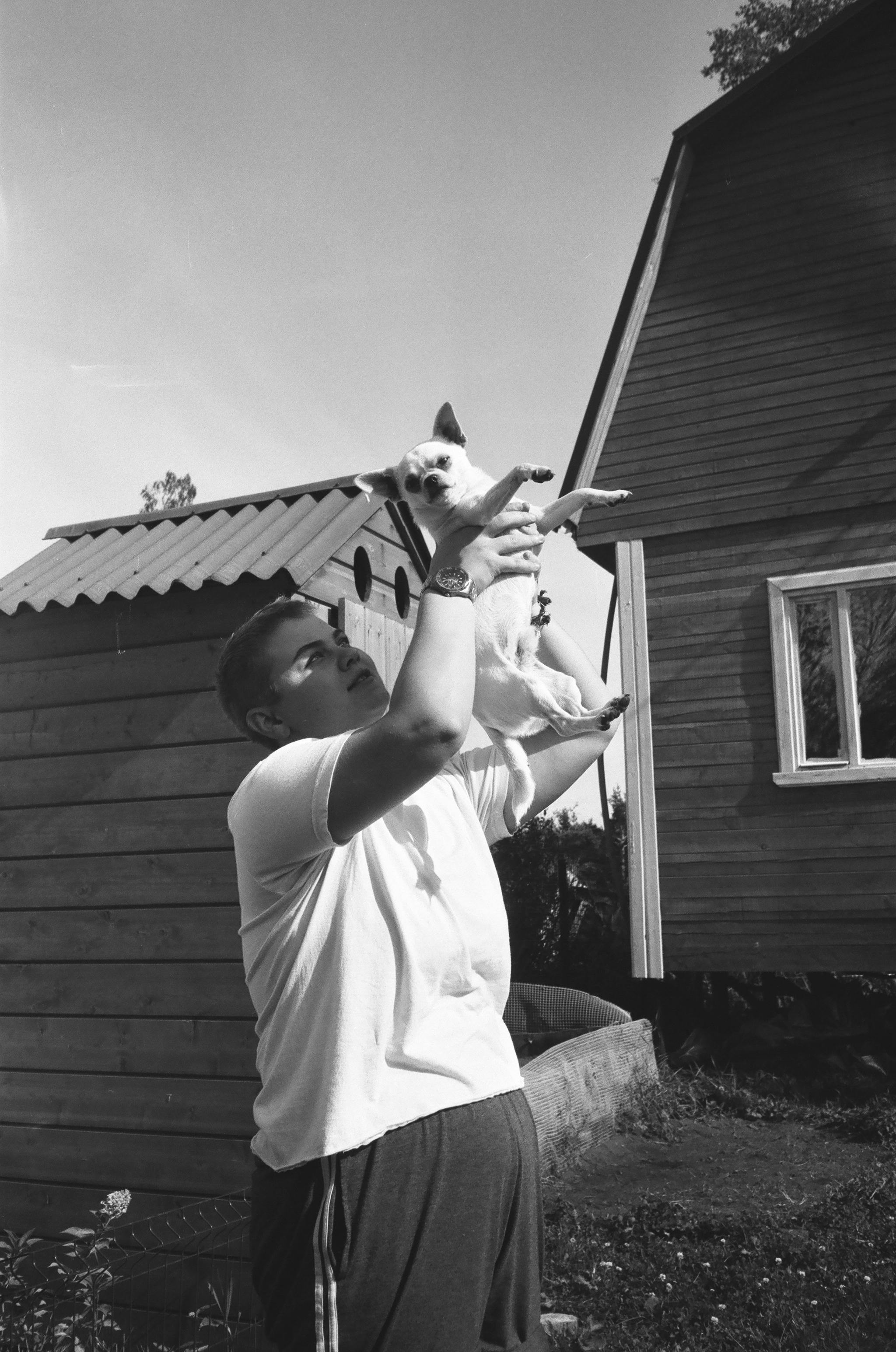 Man Carrying a Dog · Free Stock Photo