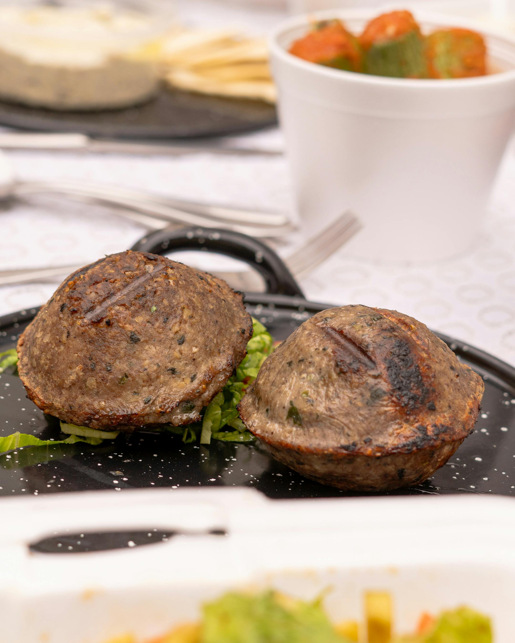 Delicious Grilled Kibbeh on Platter with Side Dish · Free Stock Photo