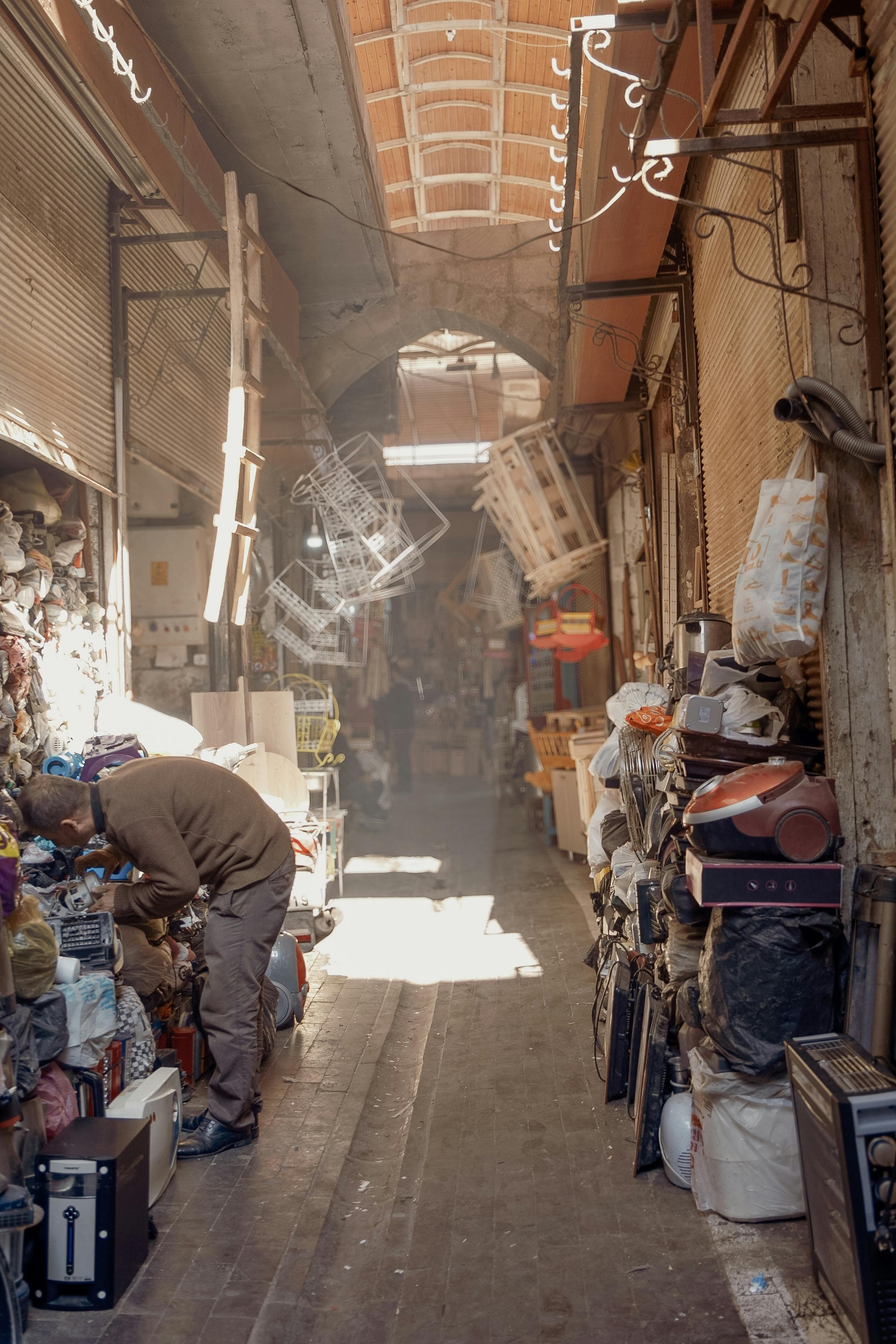 Bustling Bazaar Alley with Sunlit Stalls · Free Stock Photo