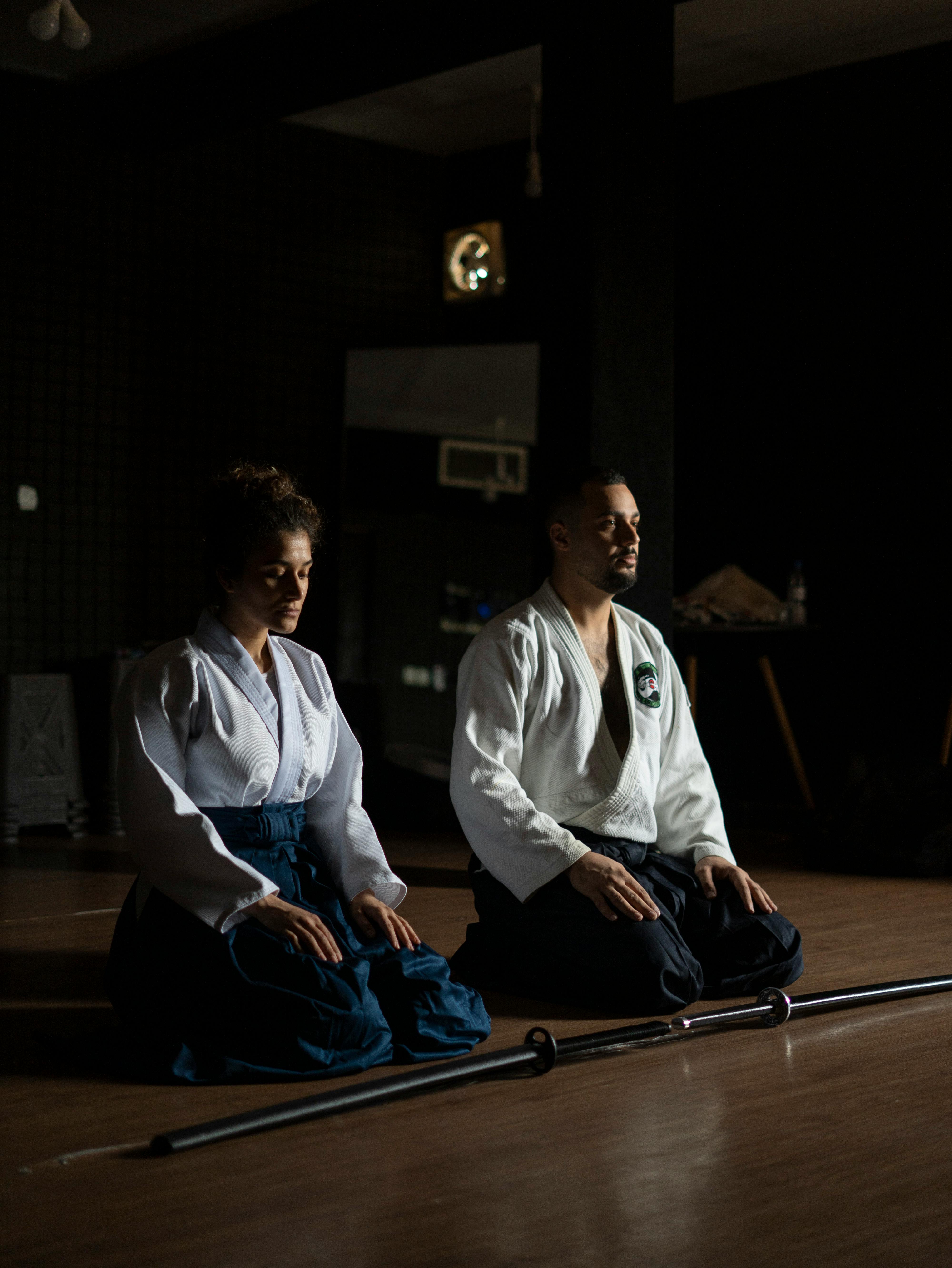 Martial Arts Training in Dimly Lit Dojo · Free Stock Photo