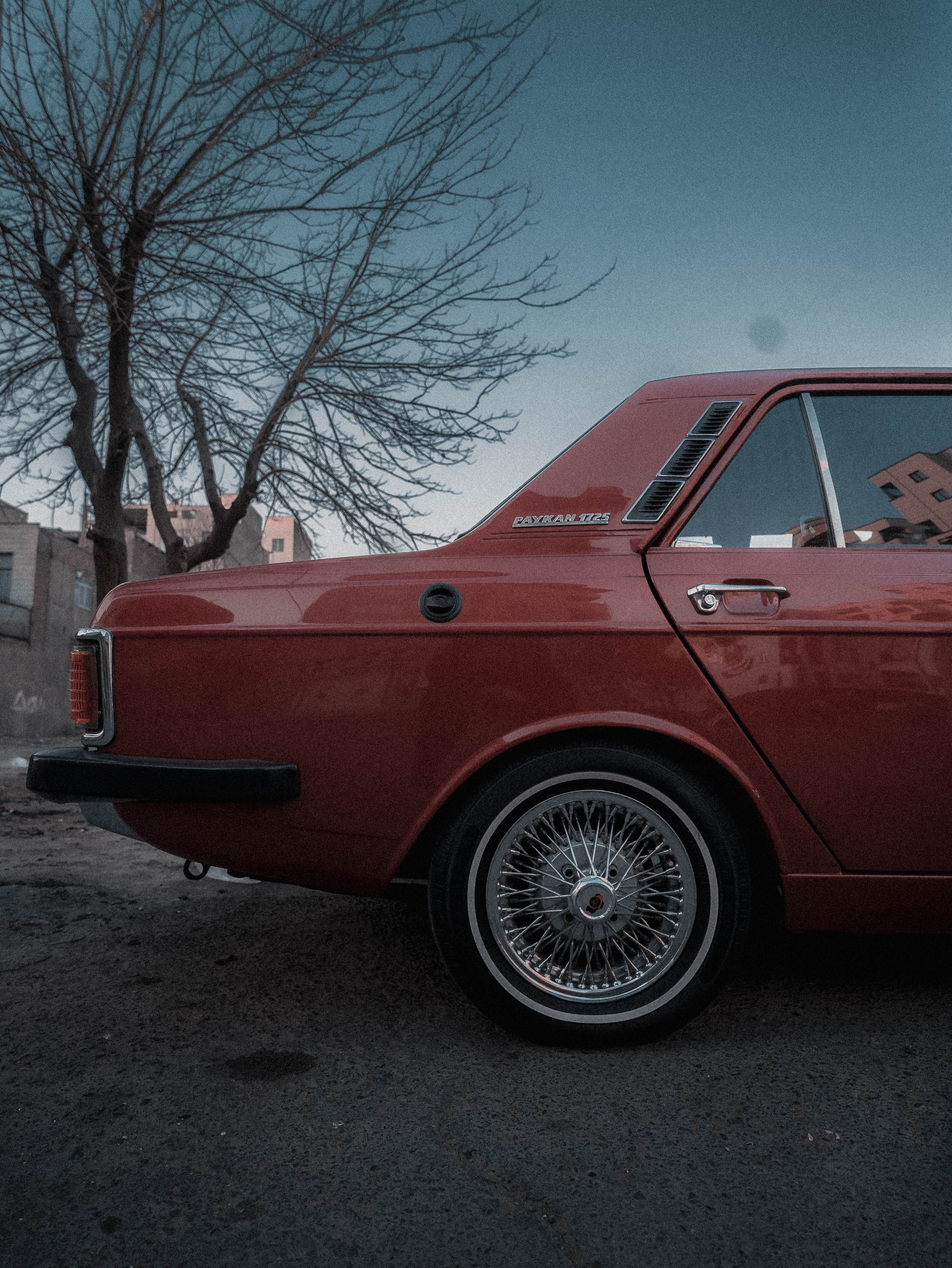 Vintage Red Car in Urban Setting at Dusk · Free Stock Photo