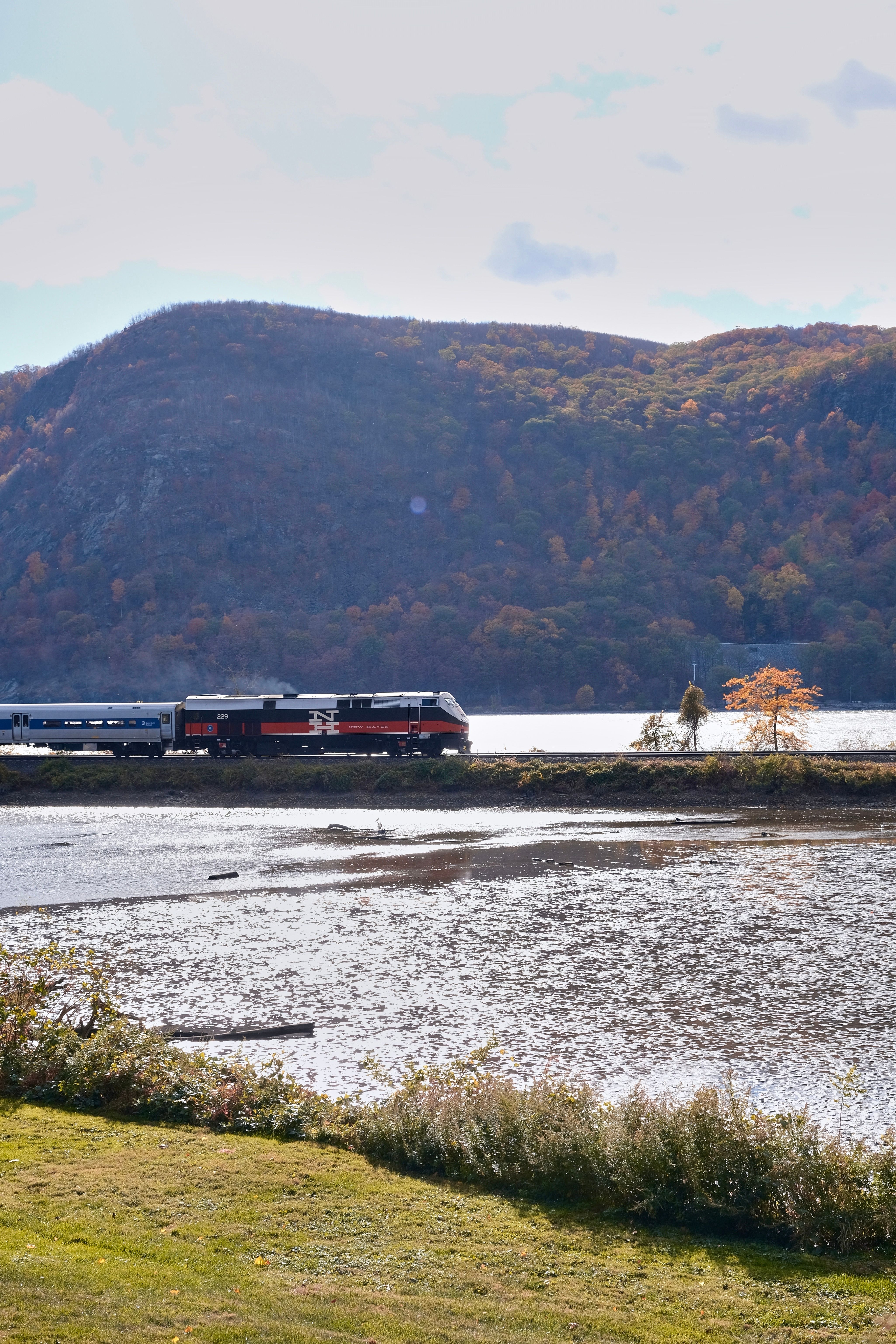 Scenic Train Ride Along Mountainous River in Fall · Free Stock Photo