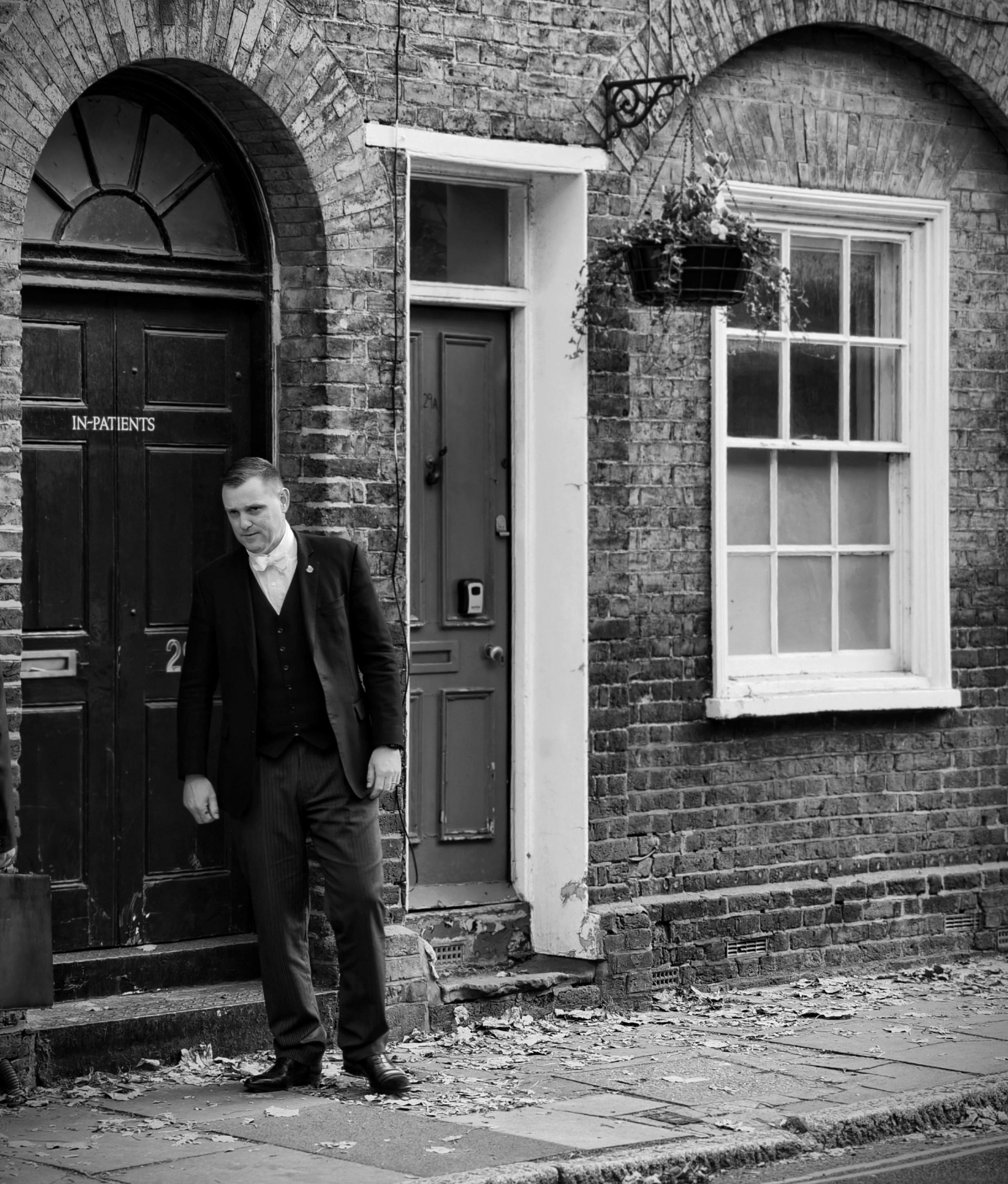 Vintage Style Portrait by Brick Building · Free Stock Photo