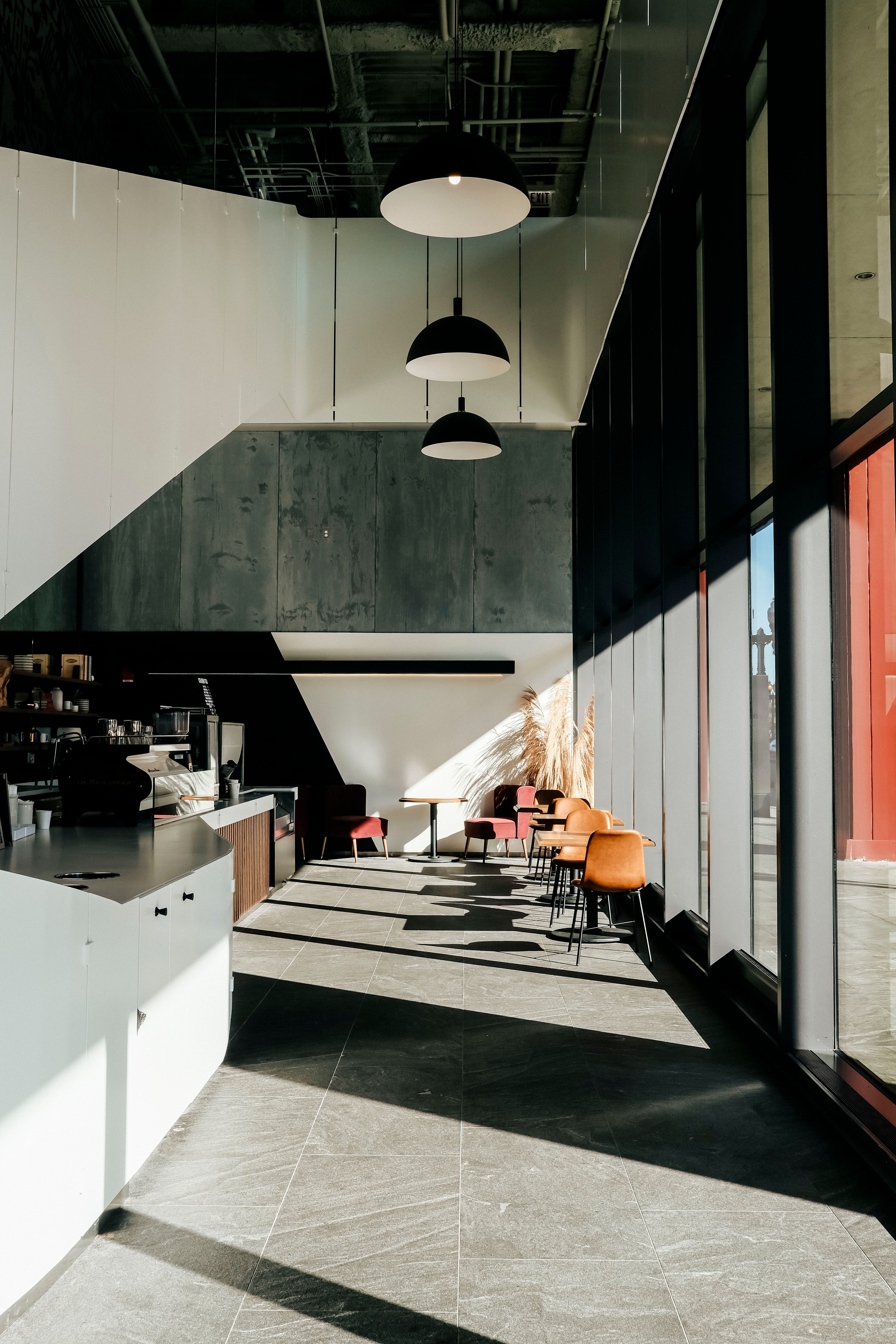 Modern Cafe Interior with Sunlit Seating Area · Free Stock Photo