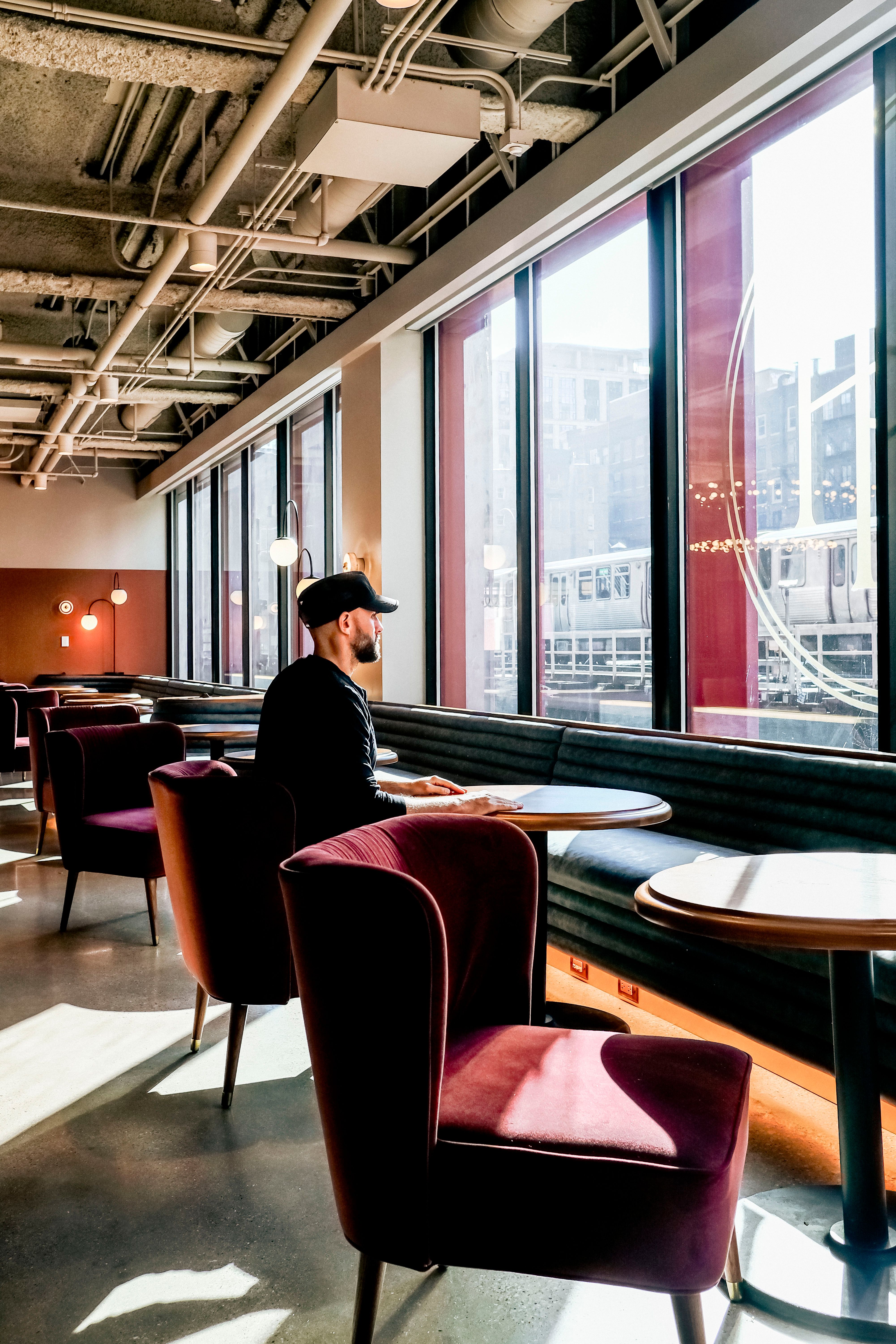 Contemplative Man in Modern Cafe Interior · Free Stock Photo