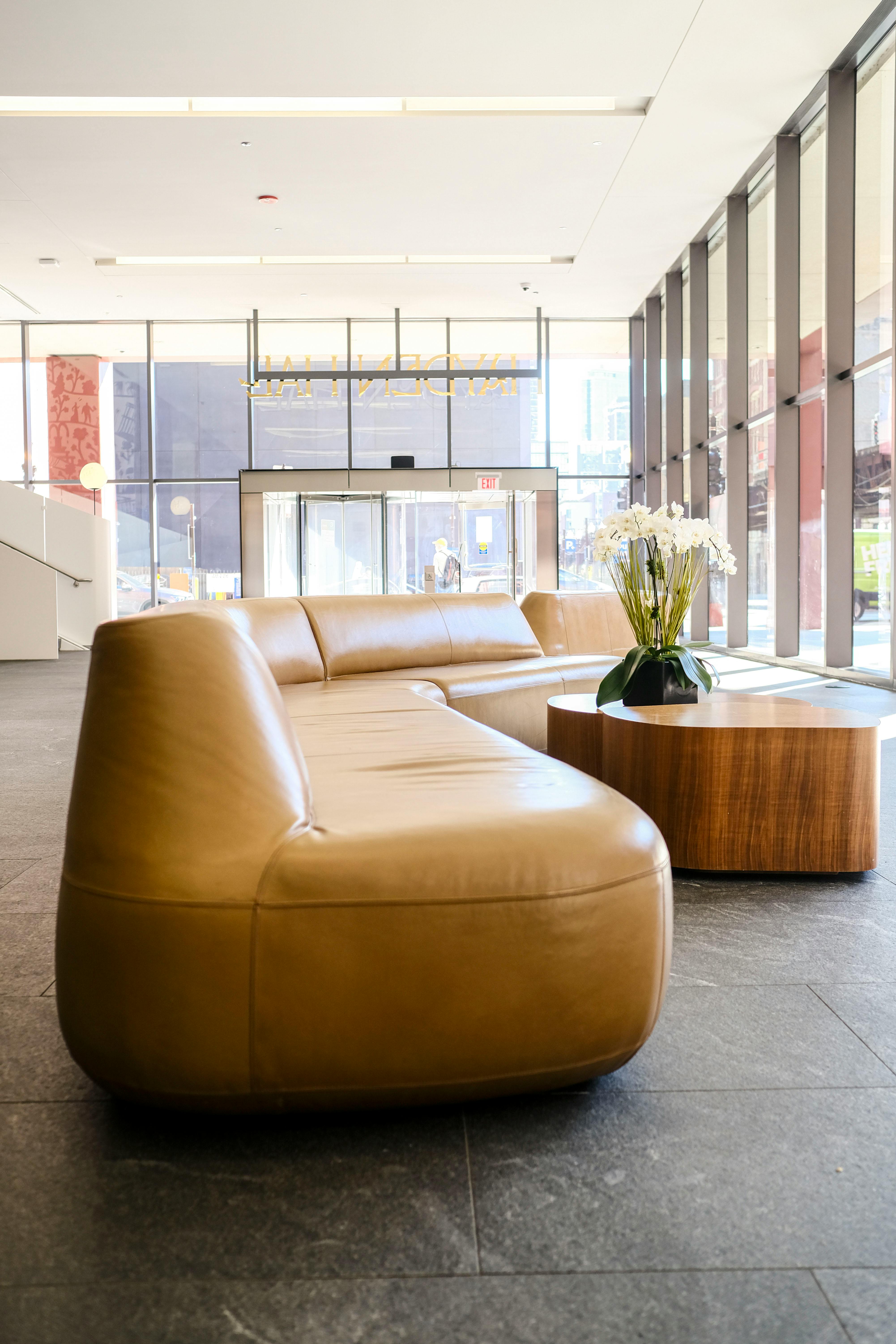 Modern Lobby with Brown Leather Sofa and Decor · Free Stock Photo