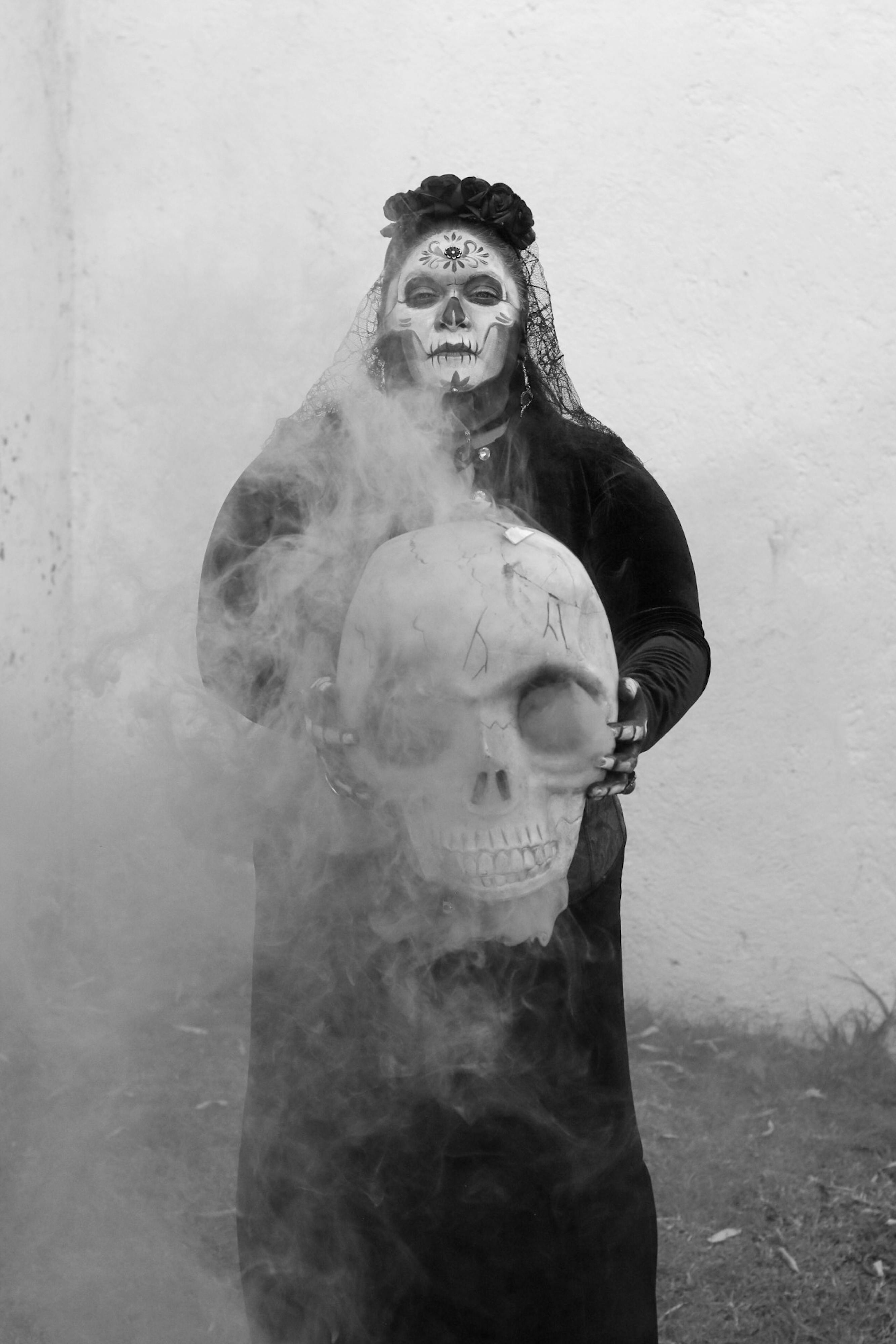 Person Holding Skull in Smoke for Halloween · Free Stock Photo