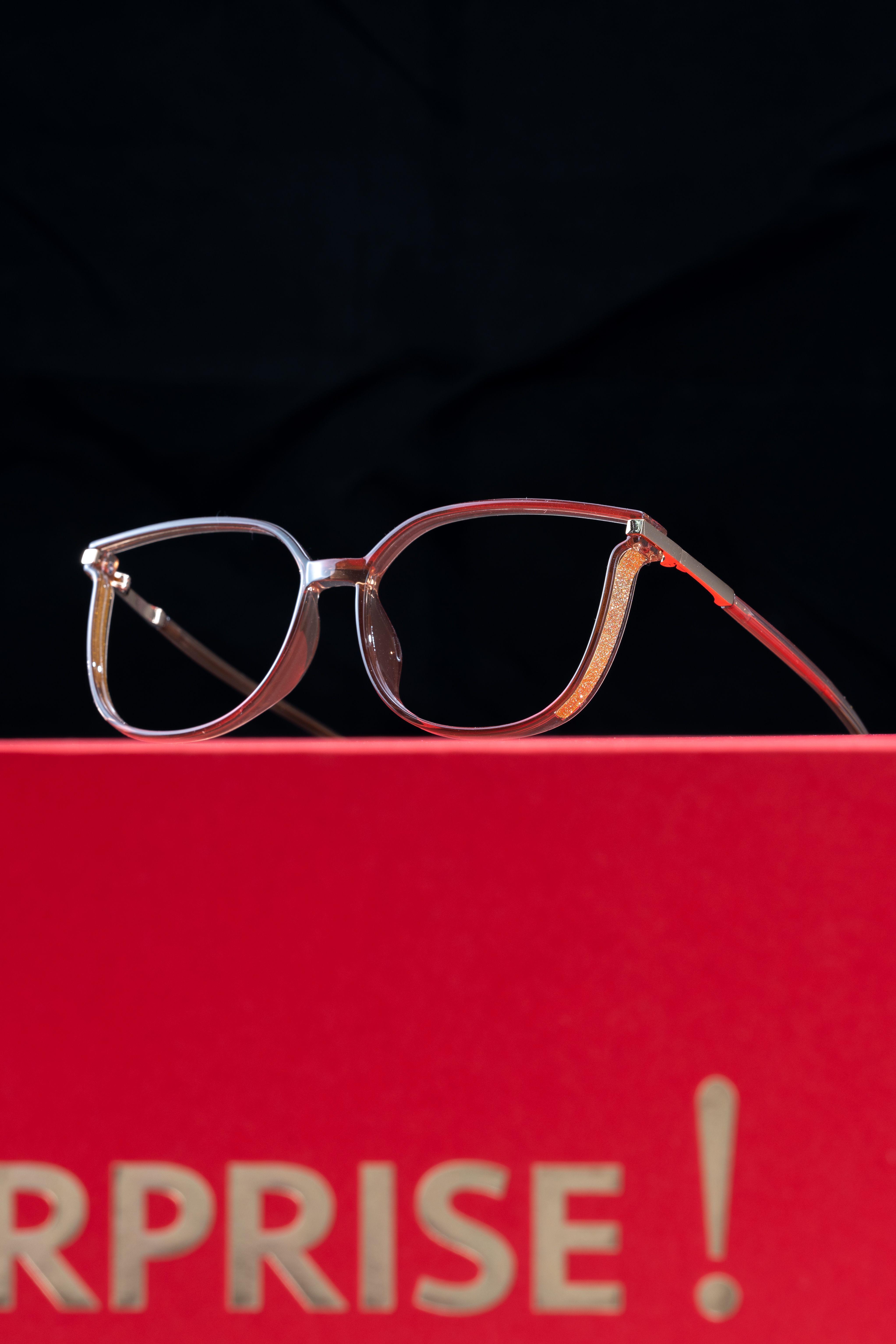 Stylish Eyeglasses on Red Background with Surprise Text · Free Stock Photo