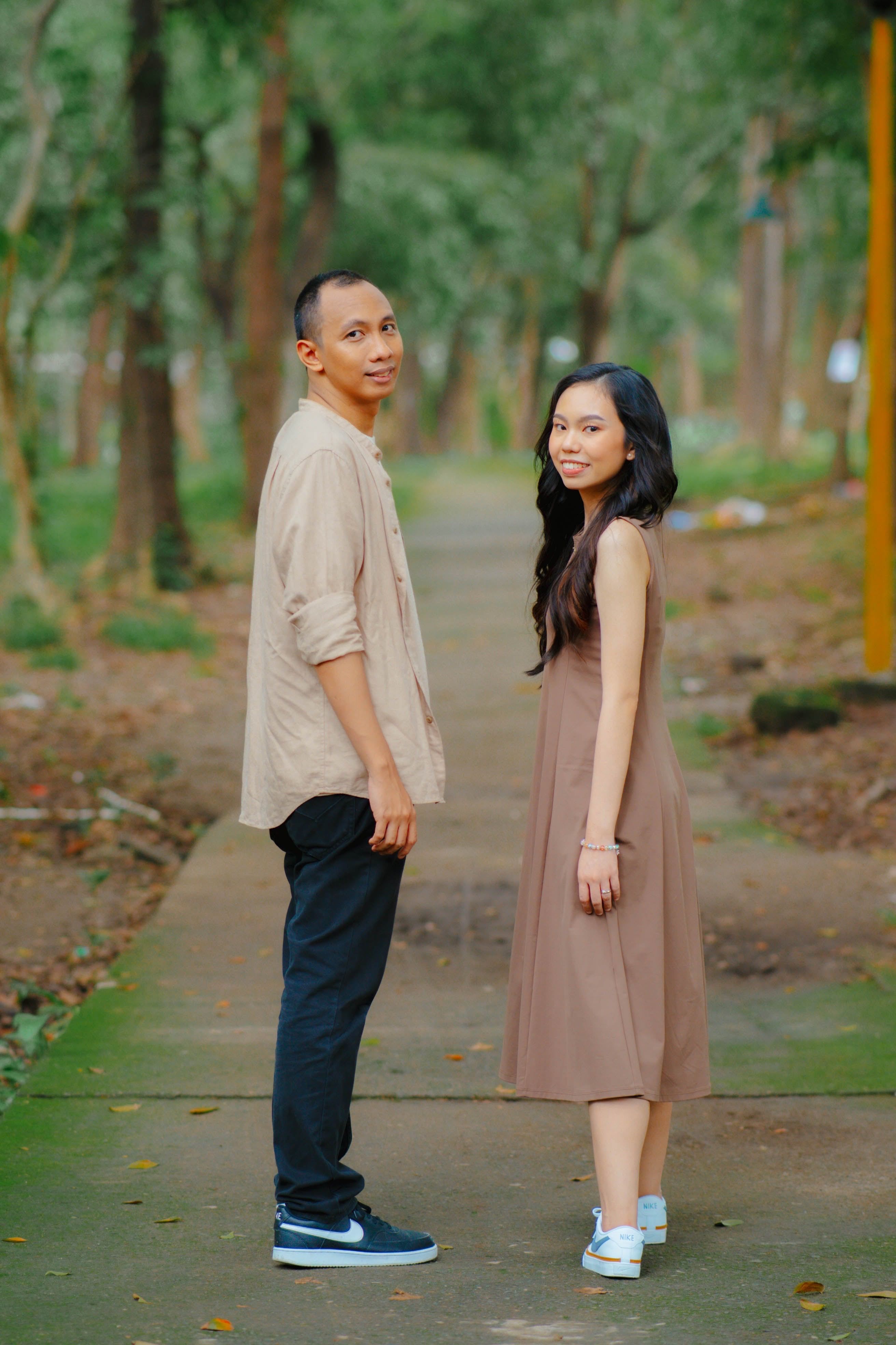 Happy Couple Standing on a Forest Path · Free Stock Photo