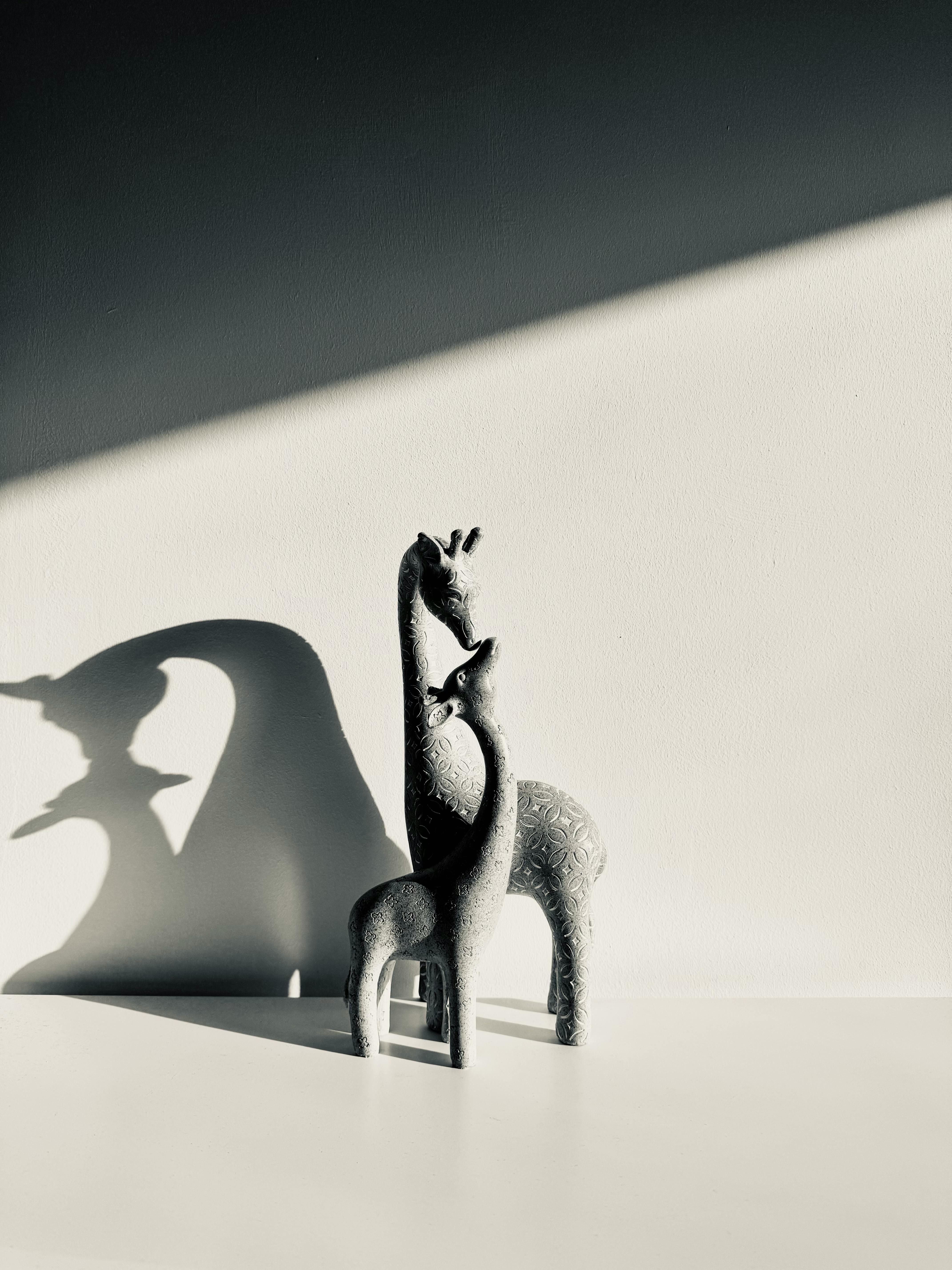 Minimalist Giraffe Statues with Dramatic Shadows · Free Stock Photo