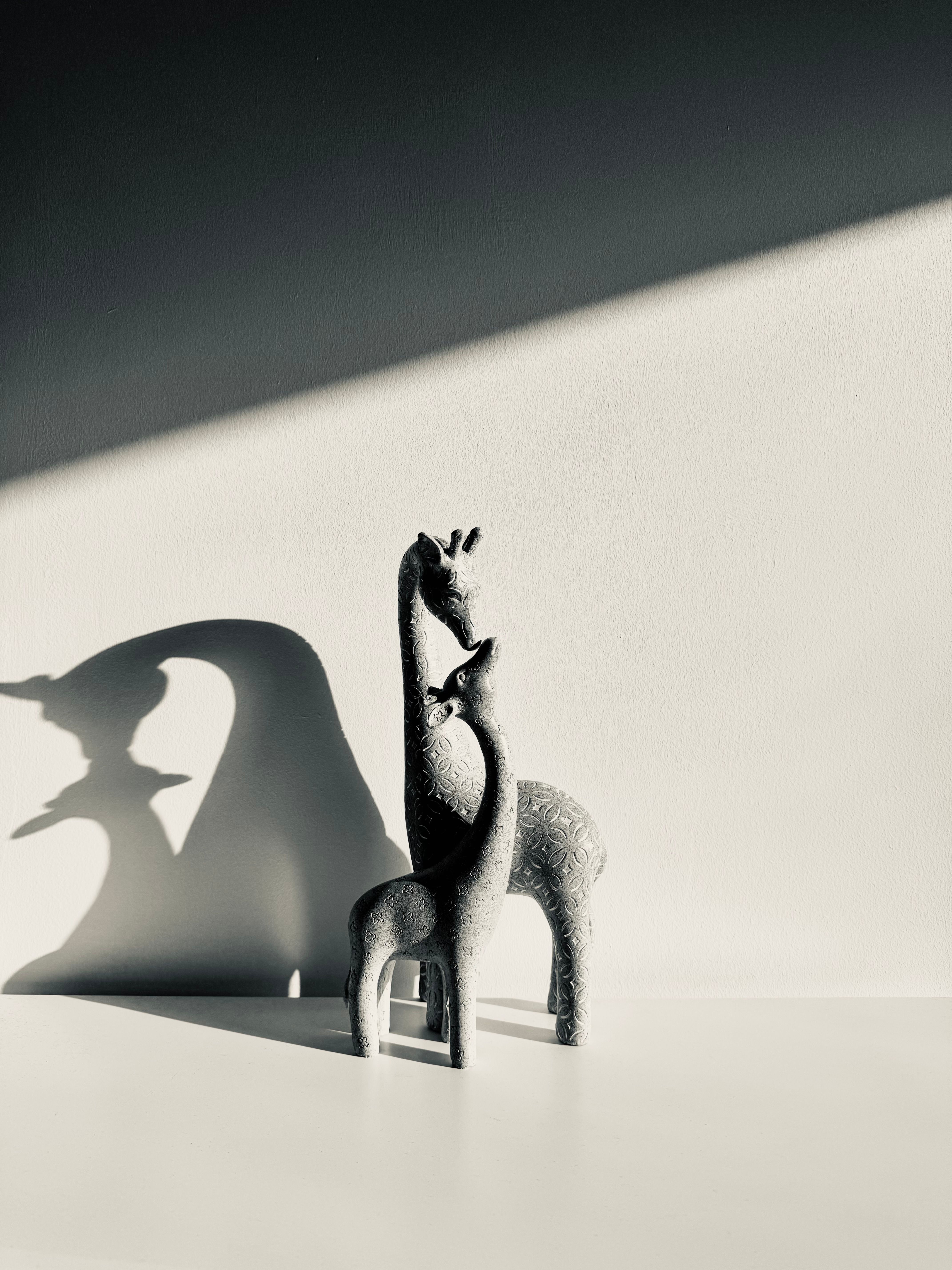 Minimalist Giraffe Statues with Dramatic Shadows · Free Stock Photo