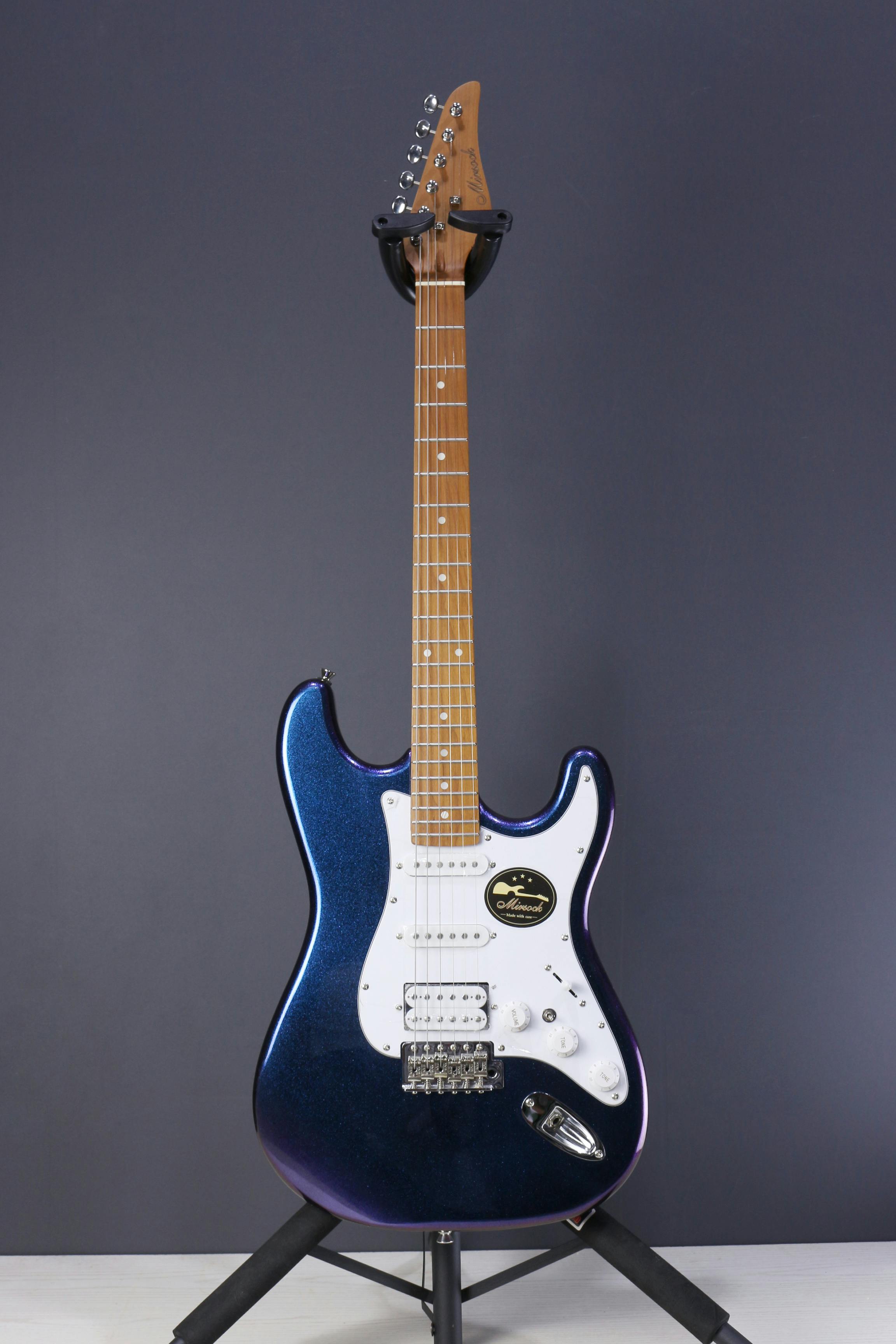 Blue Electric Guitar on a Stand Against Gray Background · Free Stock Photo