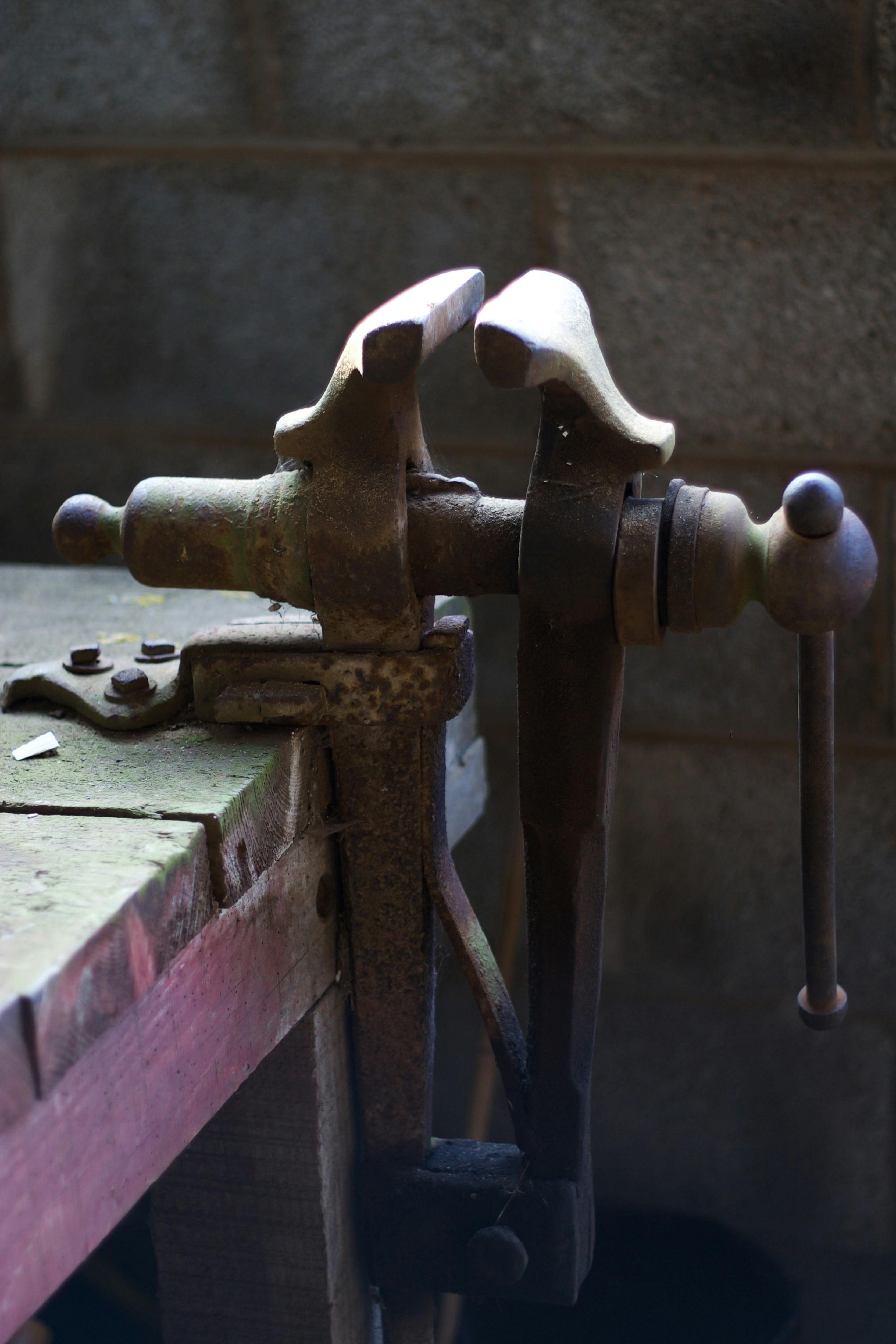 Vintage Bench Vise in Rustic Workshop Setting · Free Stock Photo