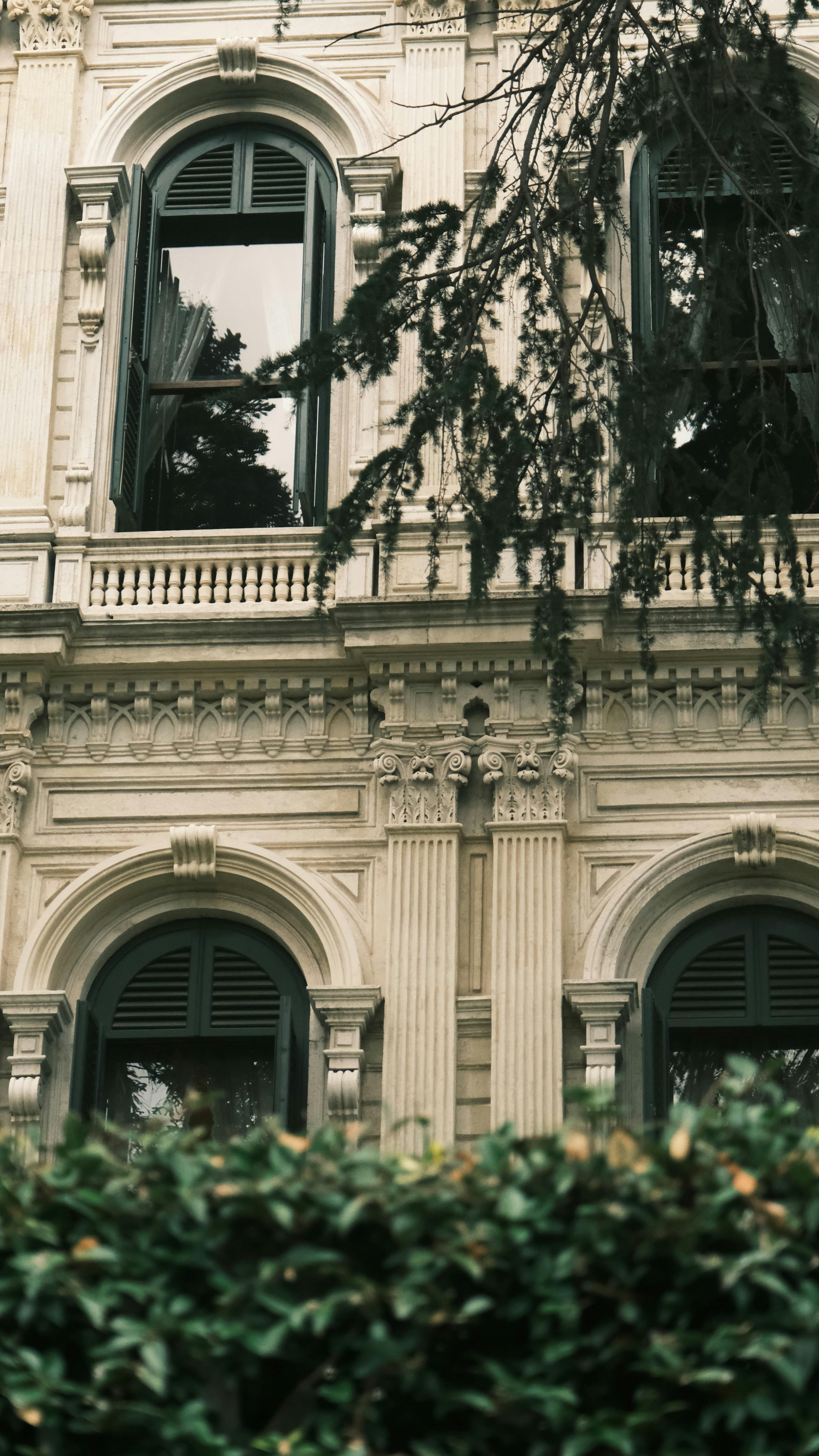 Elegant Neoclassical Building Facade with Arched Windows · Free Stock Photo