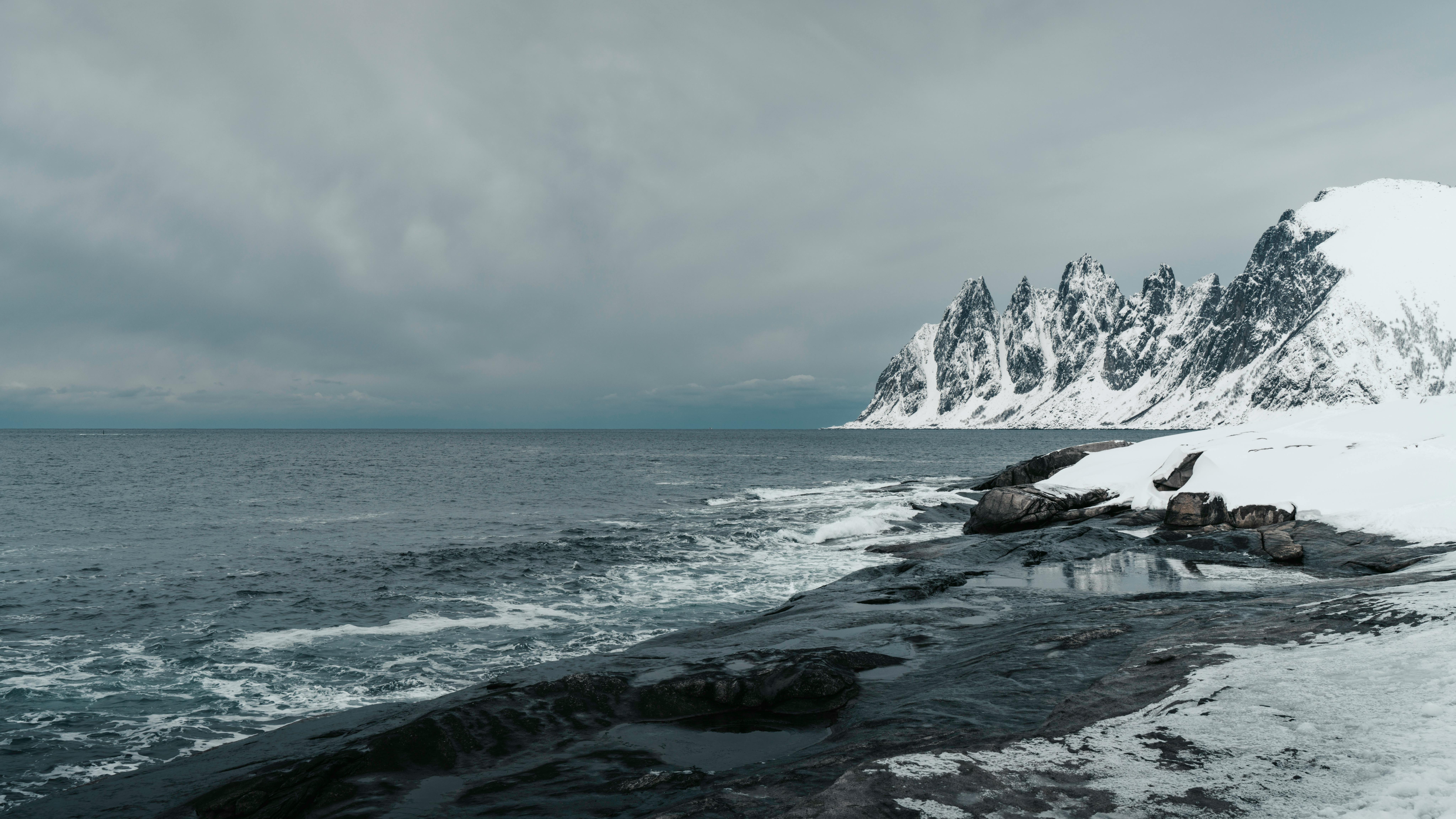 Snowy Arctic Coastline with Majestic Mountains · Free Stock Photo