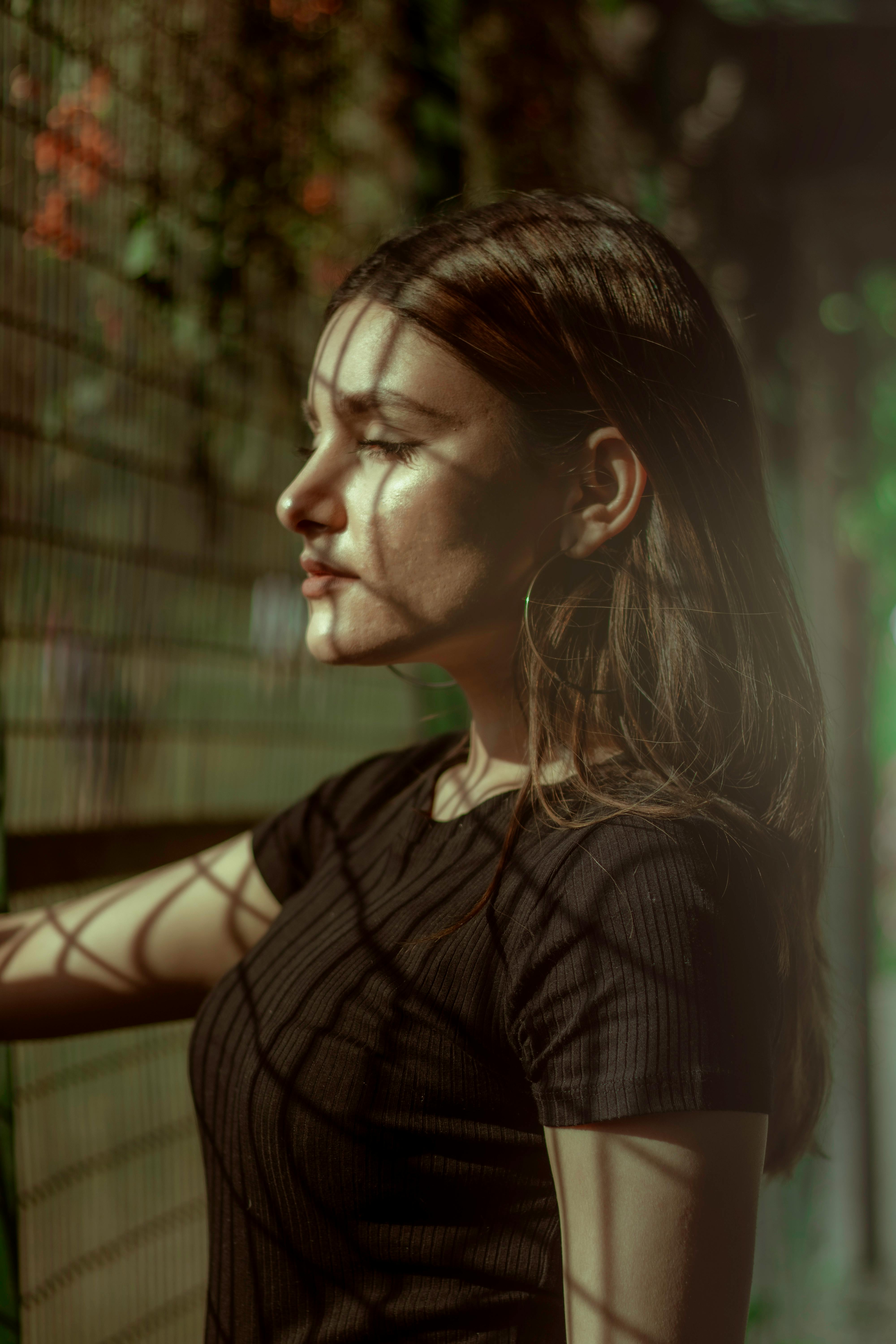 Side View Photo Of Woman Beside Fence · Free Stock Photo