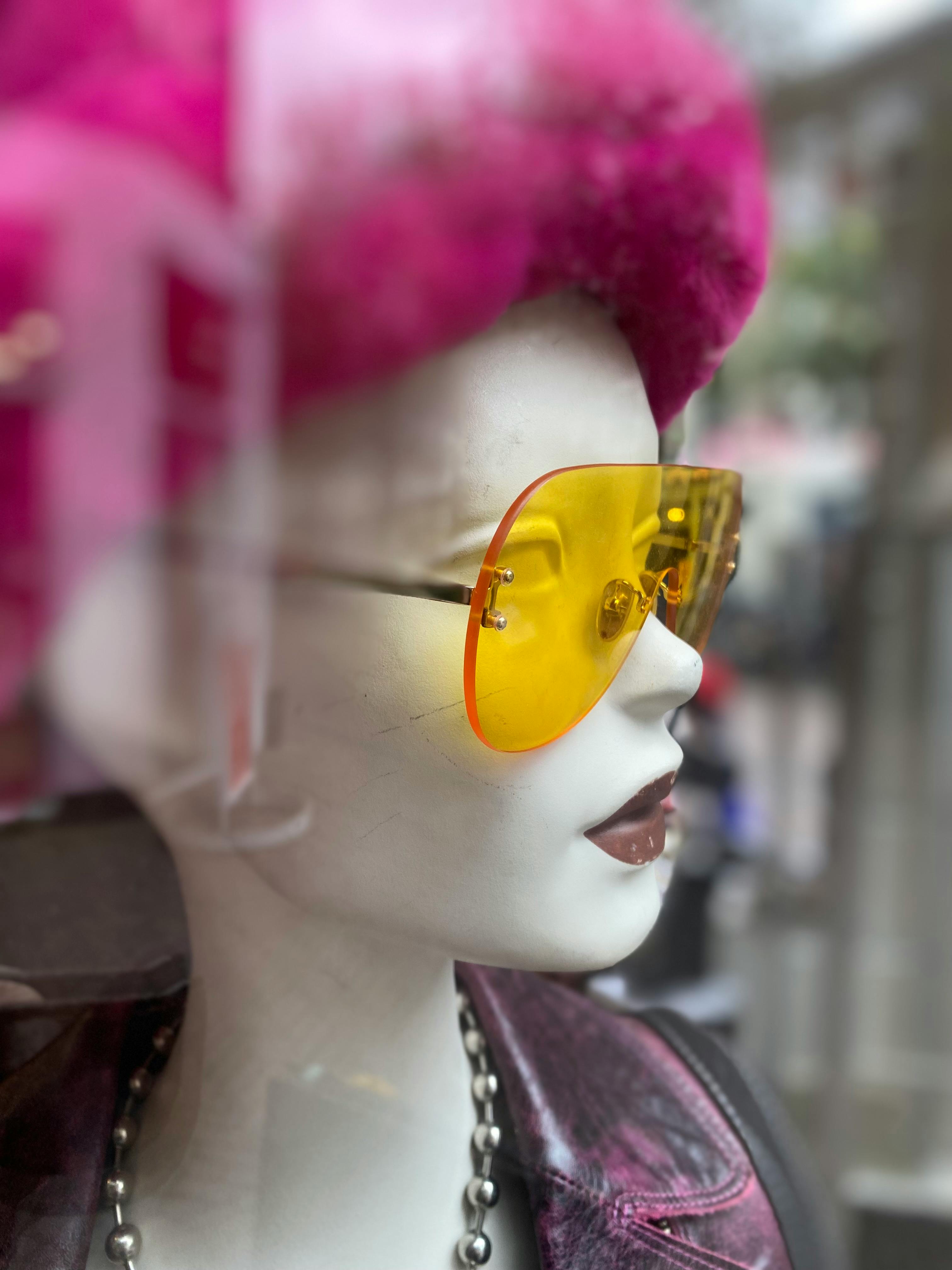 Mannequin with Stylish Yellow Sunglasses in Storefront · Free Stock Photo