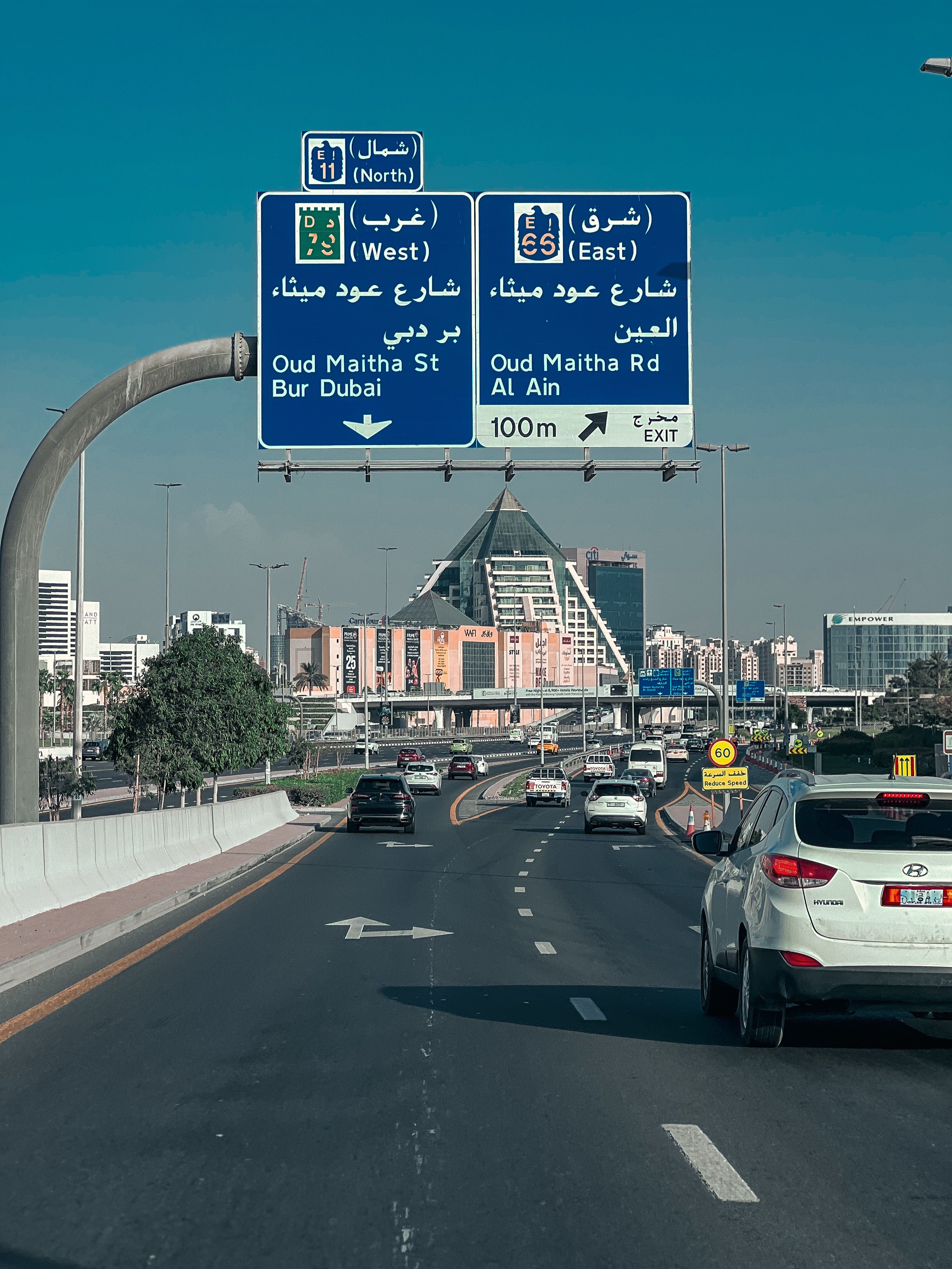 Highway Sign in Dubai with Cityscape View · Free Stock Photo