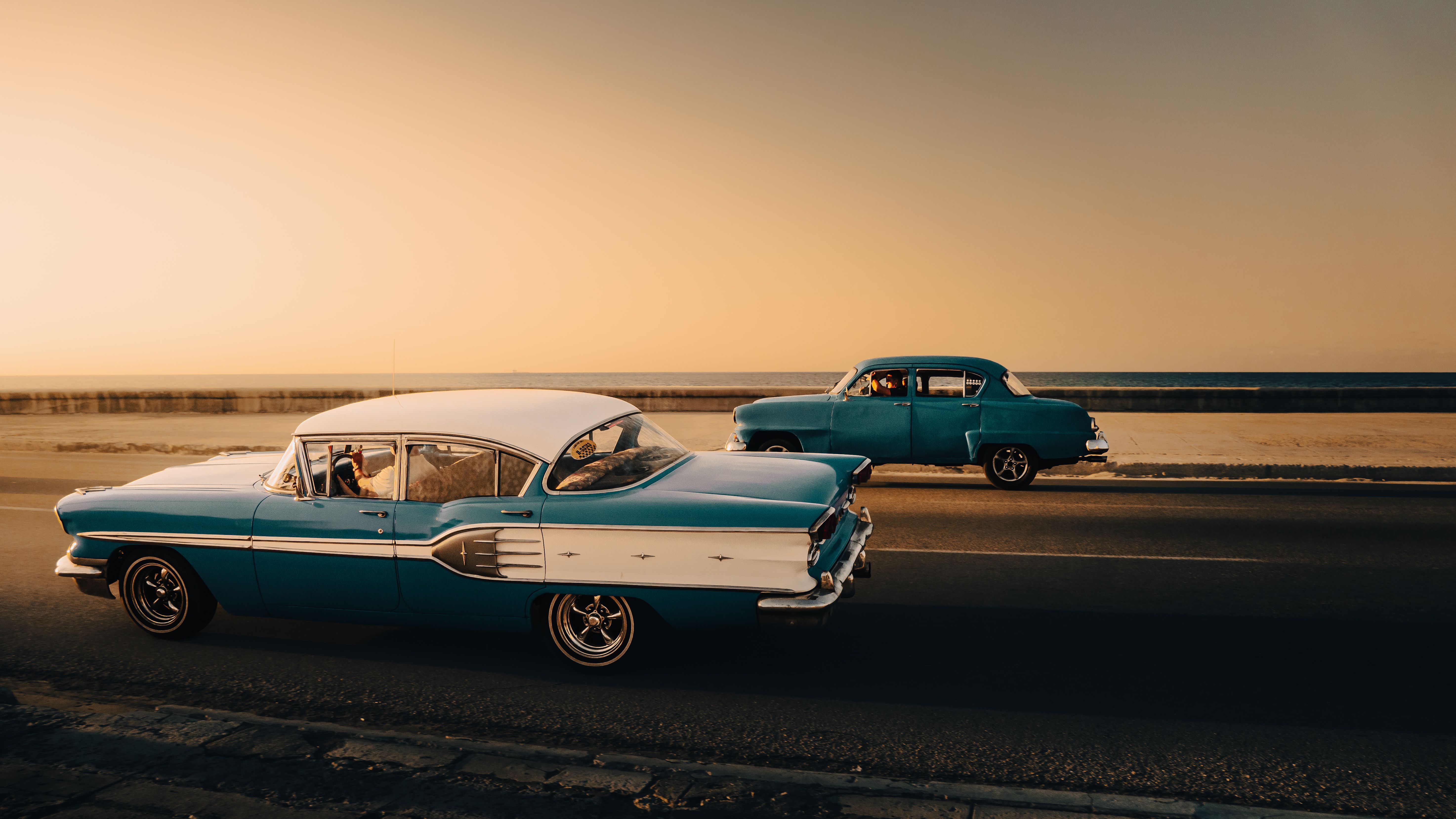 Vintage Cars on Seaside Road at Sunset · Free Stock Photo