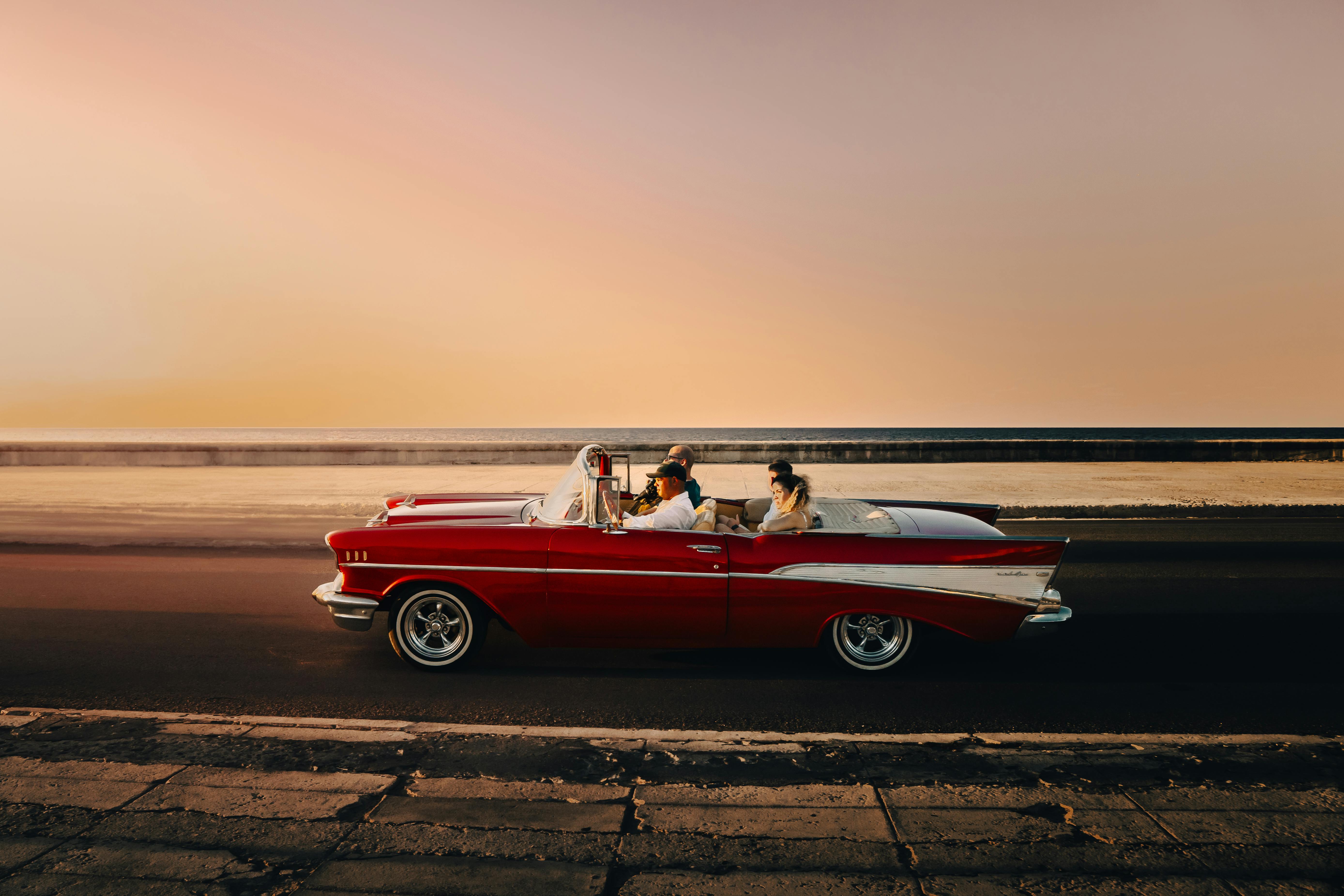 Vintage Convertible Sunset Drive by the Coast · Free Stock Photo