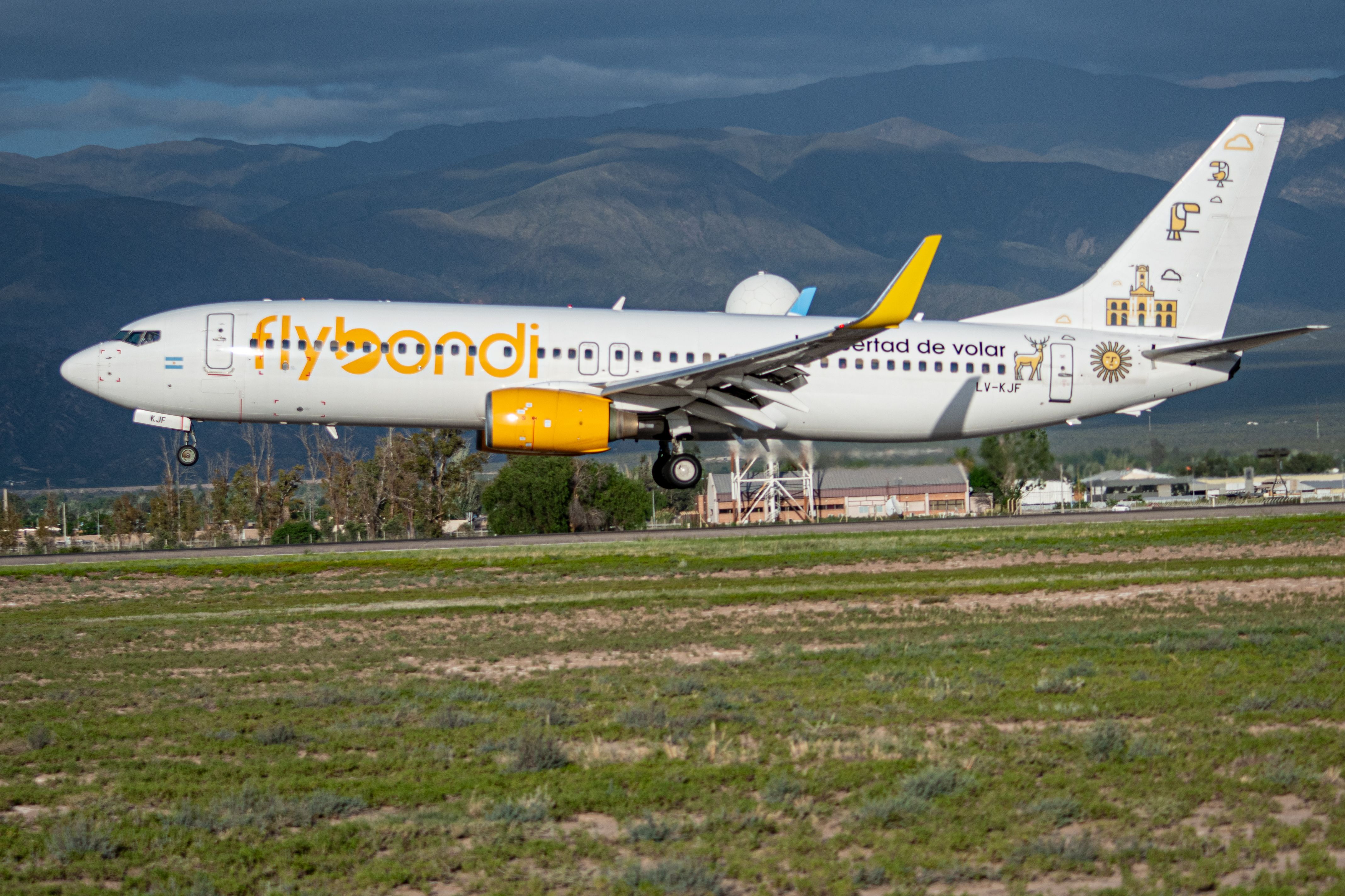 Flybondi Aircraft Landing in Scenic Mountain Area · Free Stock Photo