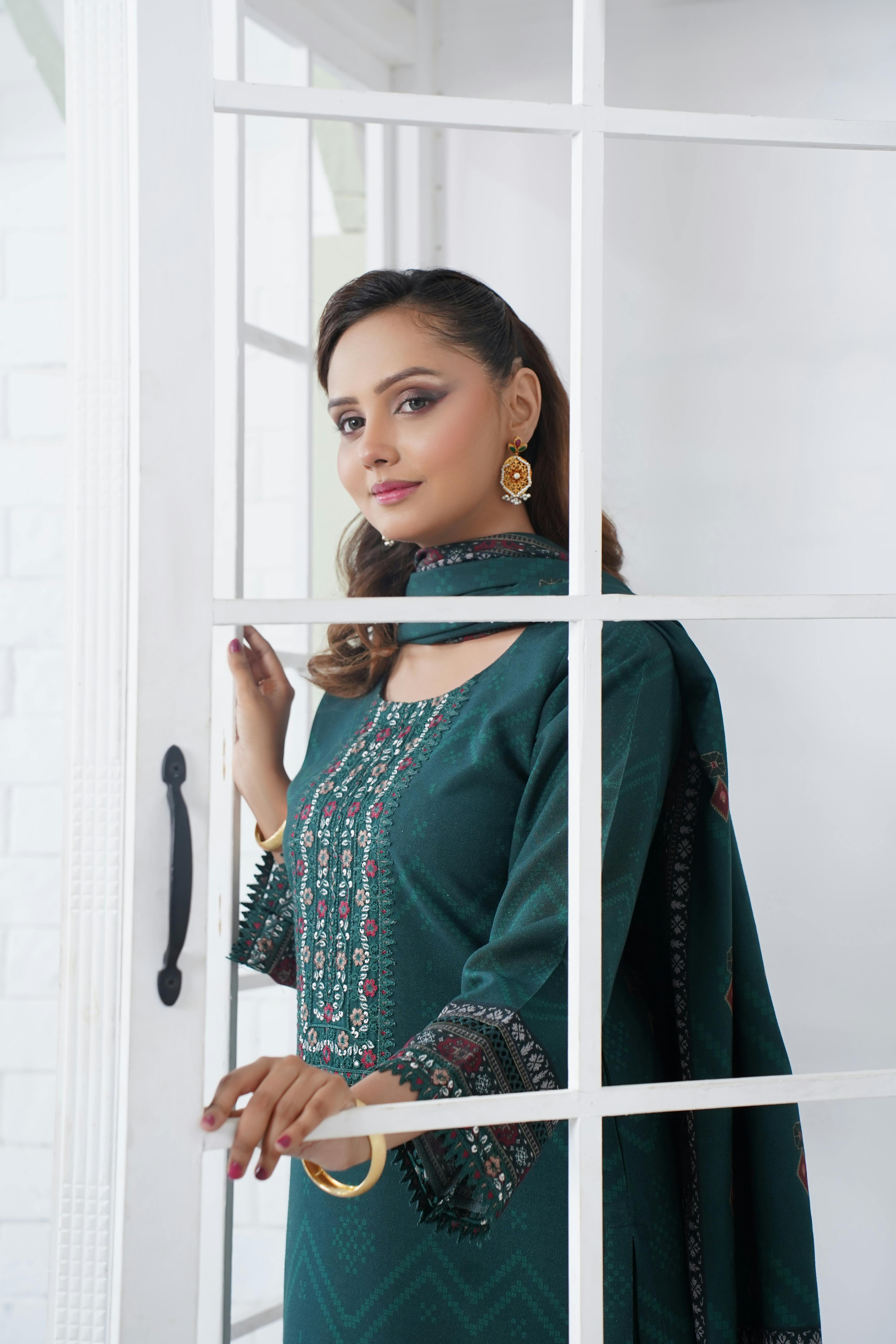 Elegant Woman in Traditional Pakistani Dress by Window · Free Stock Photo