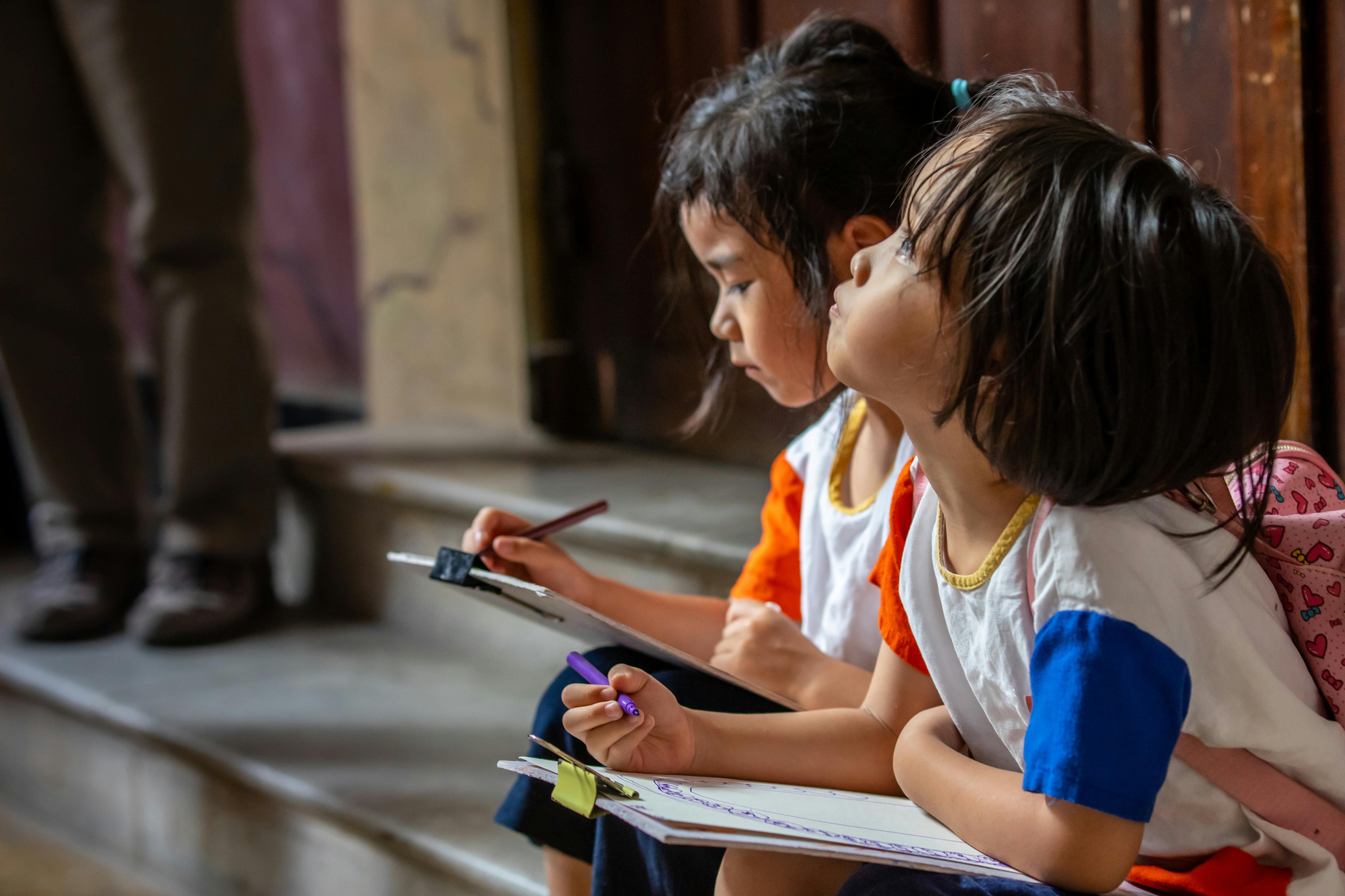 Children Drawing Indoors with Focused Expressions · Free Stock Photo