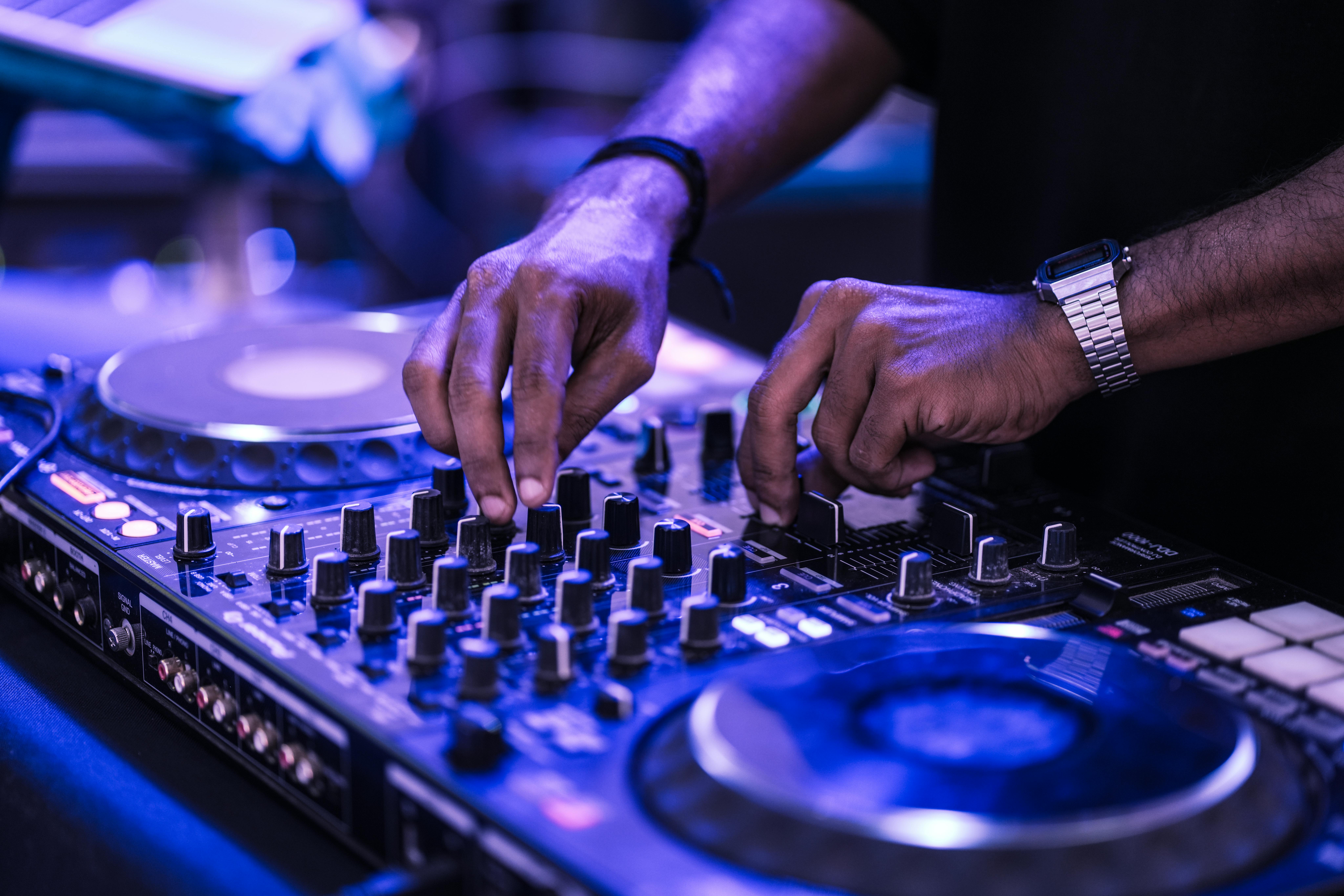 DJ Mixing Tracks at a Night Event · Free Stock Photo
