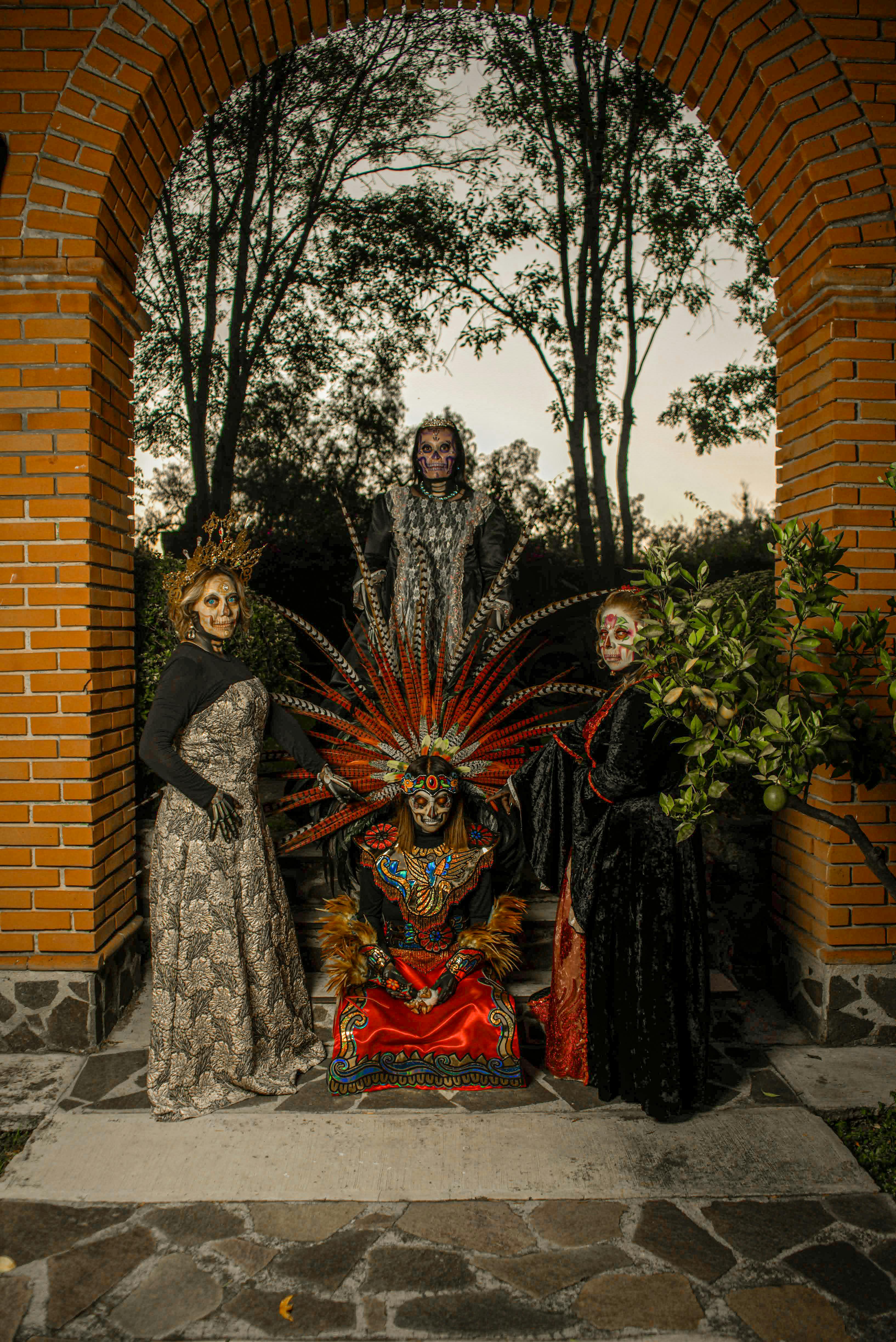 Colorful Traditional Costumes in Brick Archway · Free Stock Photo