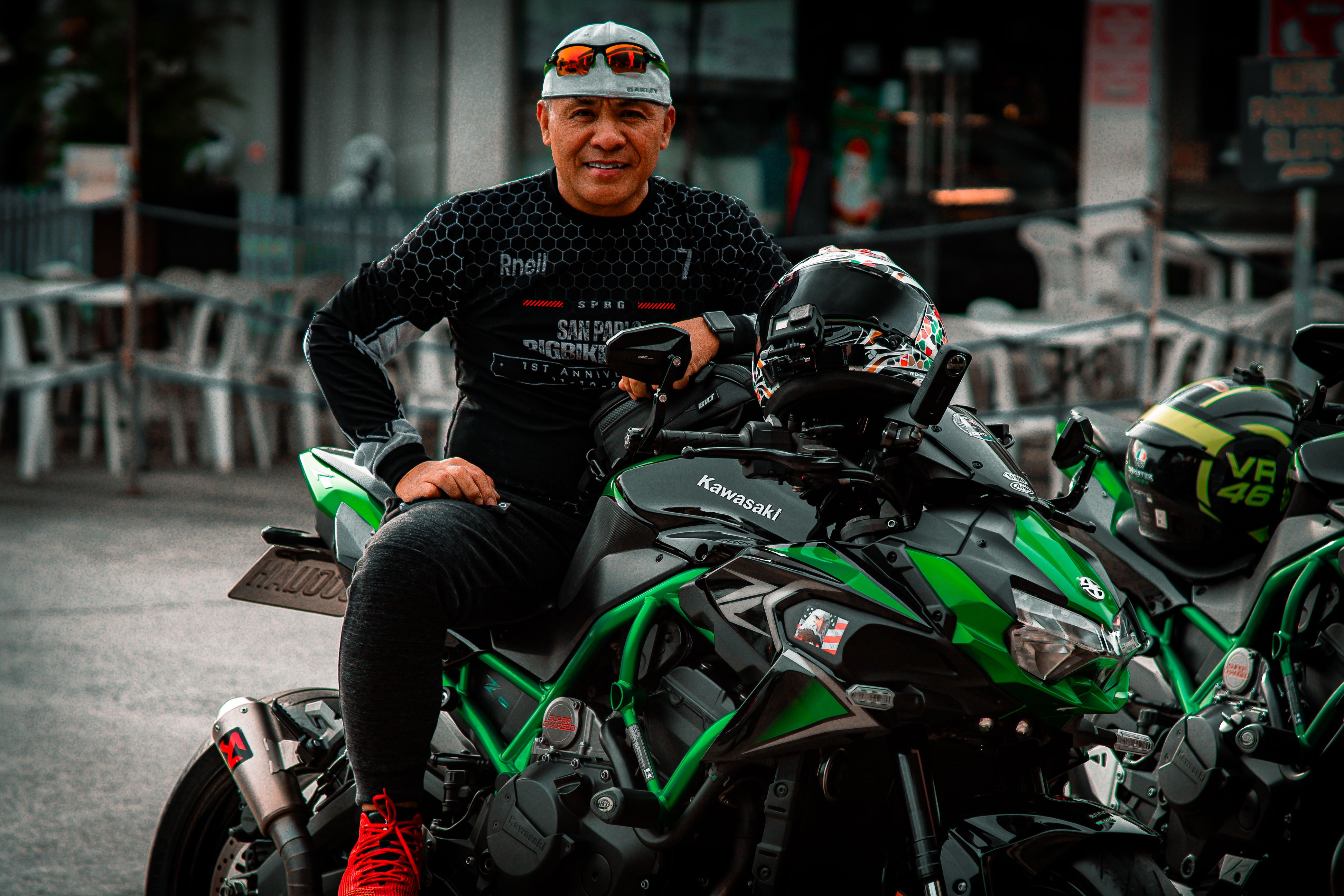 Man Posing with Kawasaki Motorcycle Outdoors · Free Stock Photo