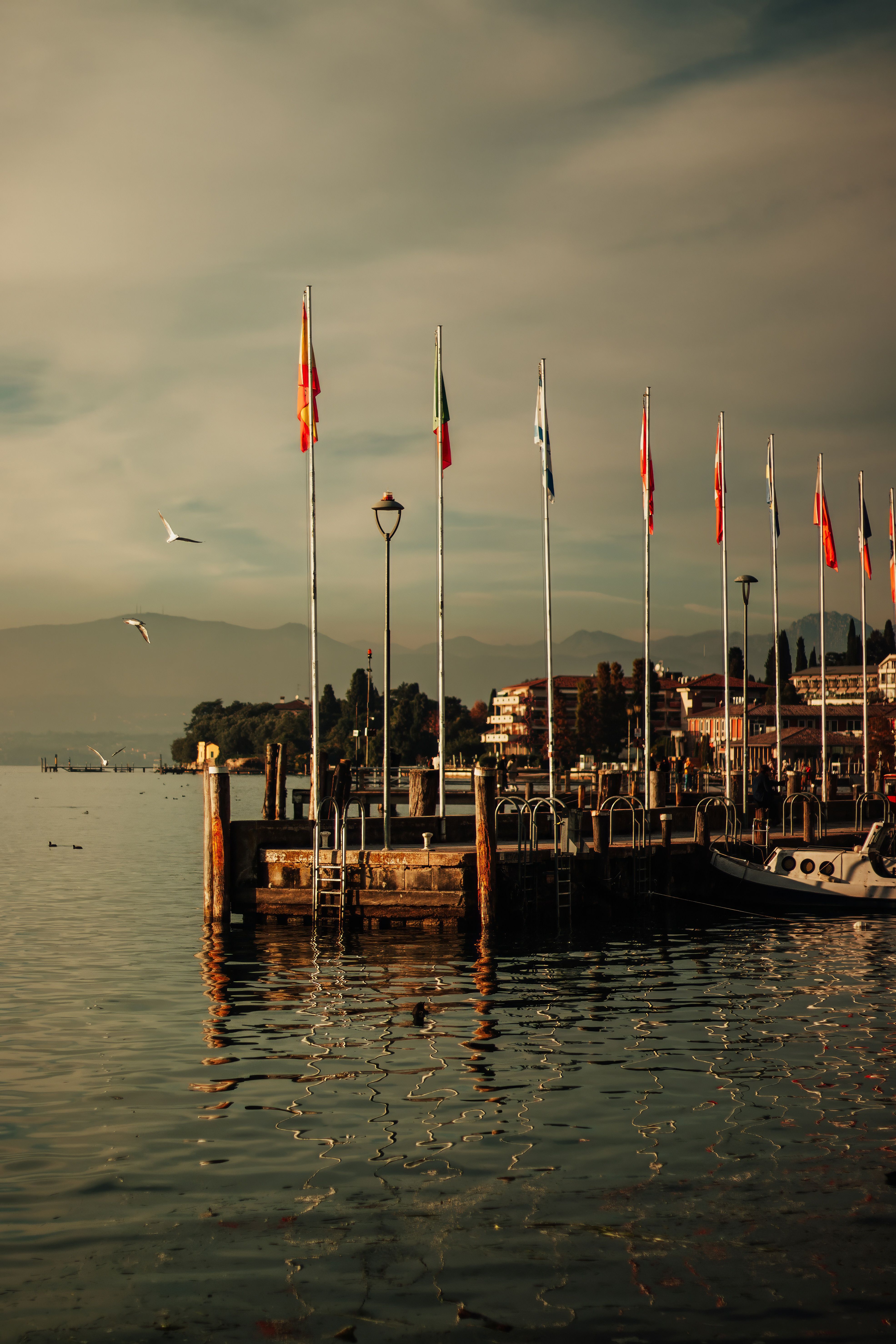 Scenic Waterfront View with Flags in Italy · Free Stock Photo