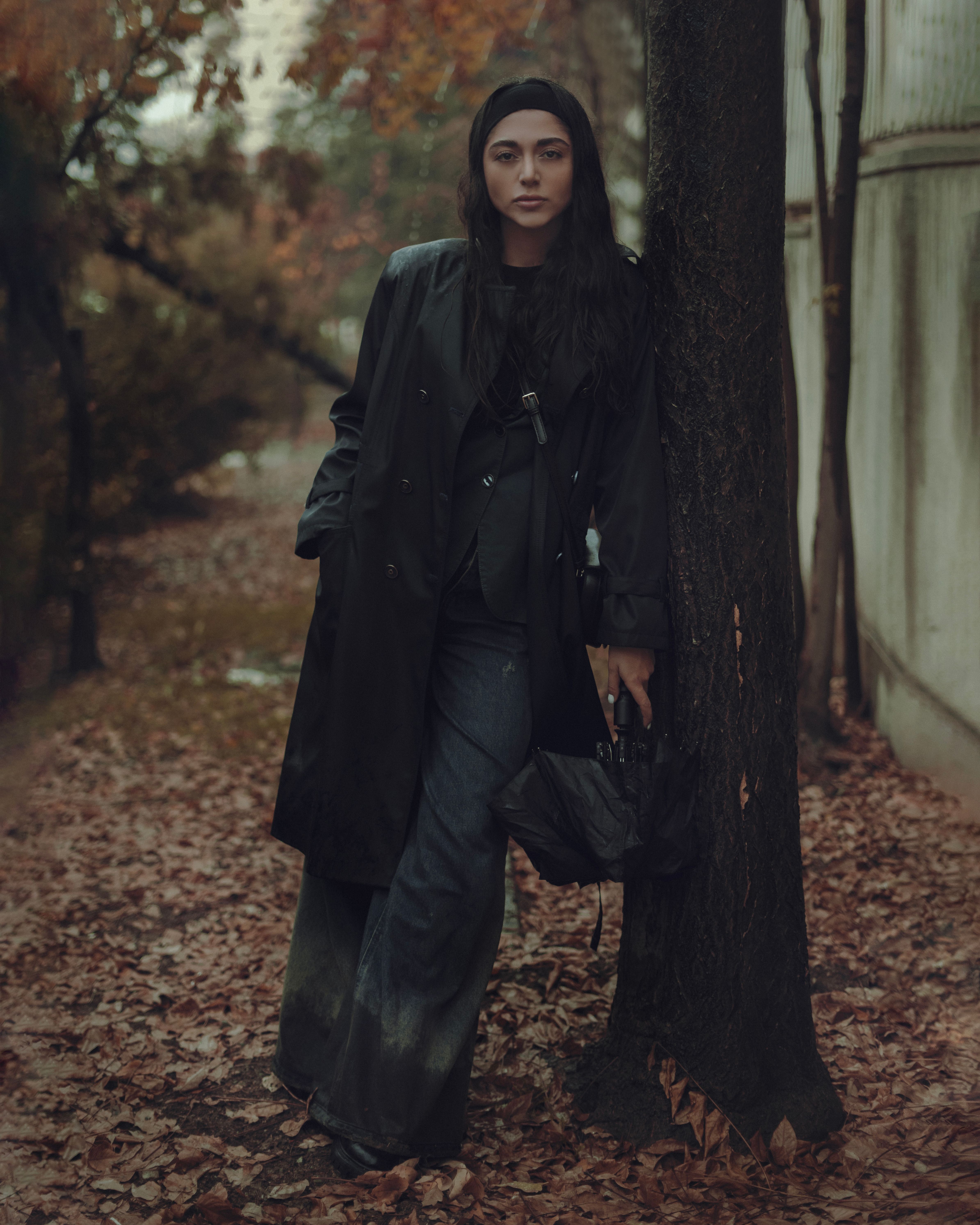 Woman in Fall Attire Leaning on Tree Outdoors · Free Stock Photo