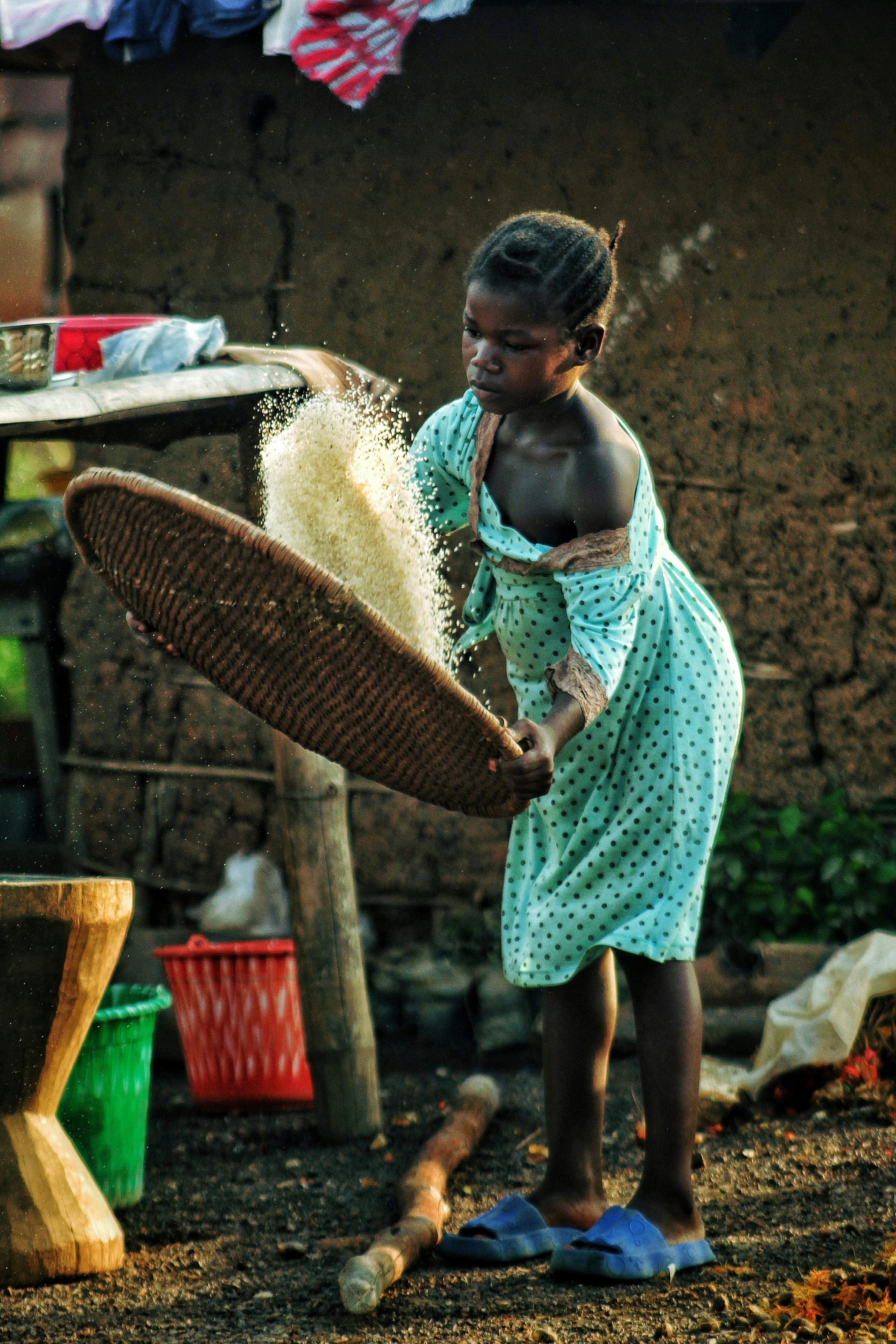 Young Girl Drying Rice in Rural Liberia · Free Stock Photo