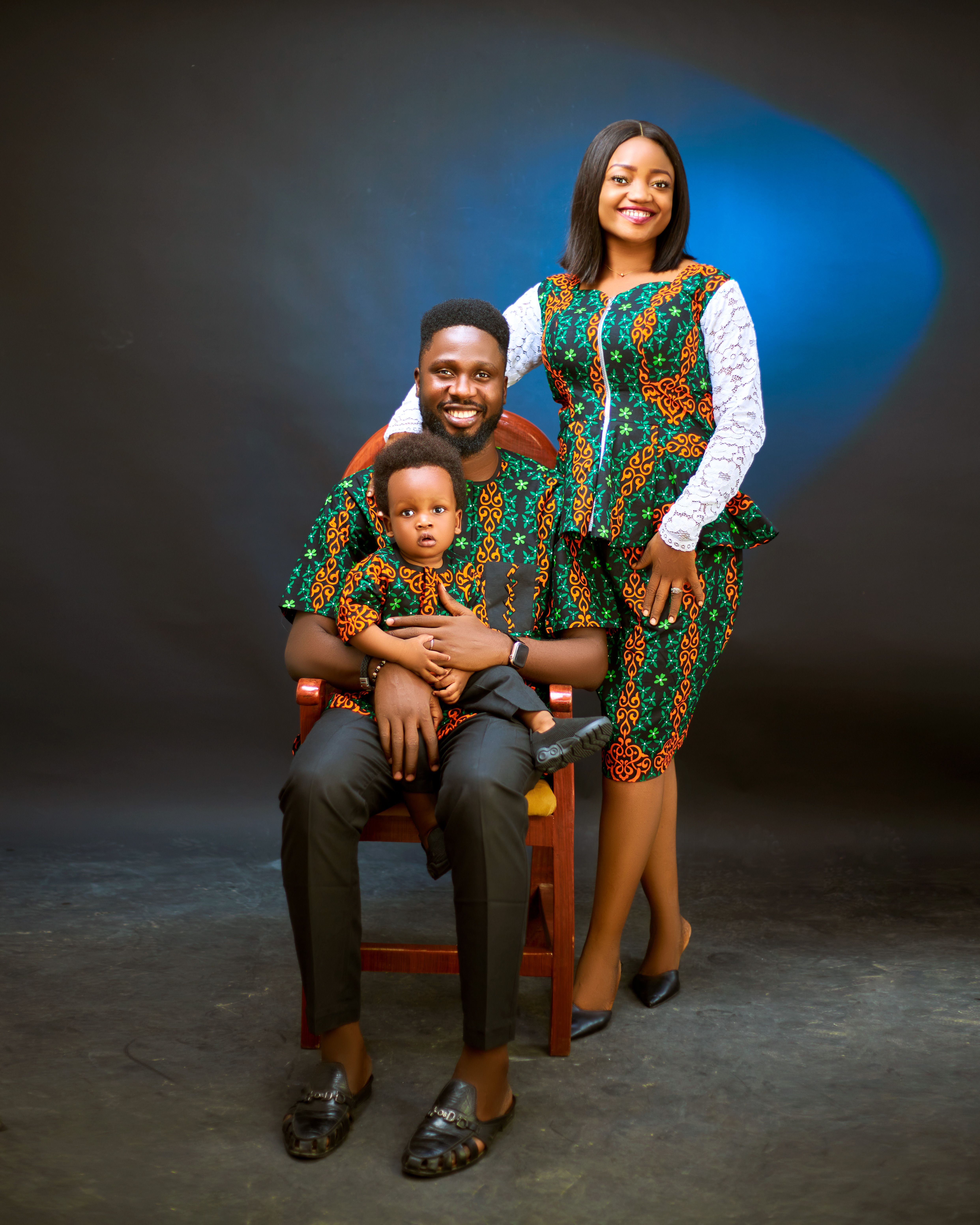 Happy Family Posing in Matching Traditional Attire · Free Stock Photo