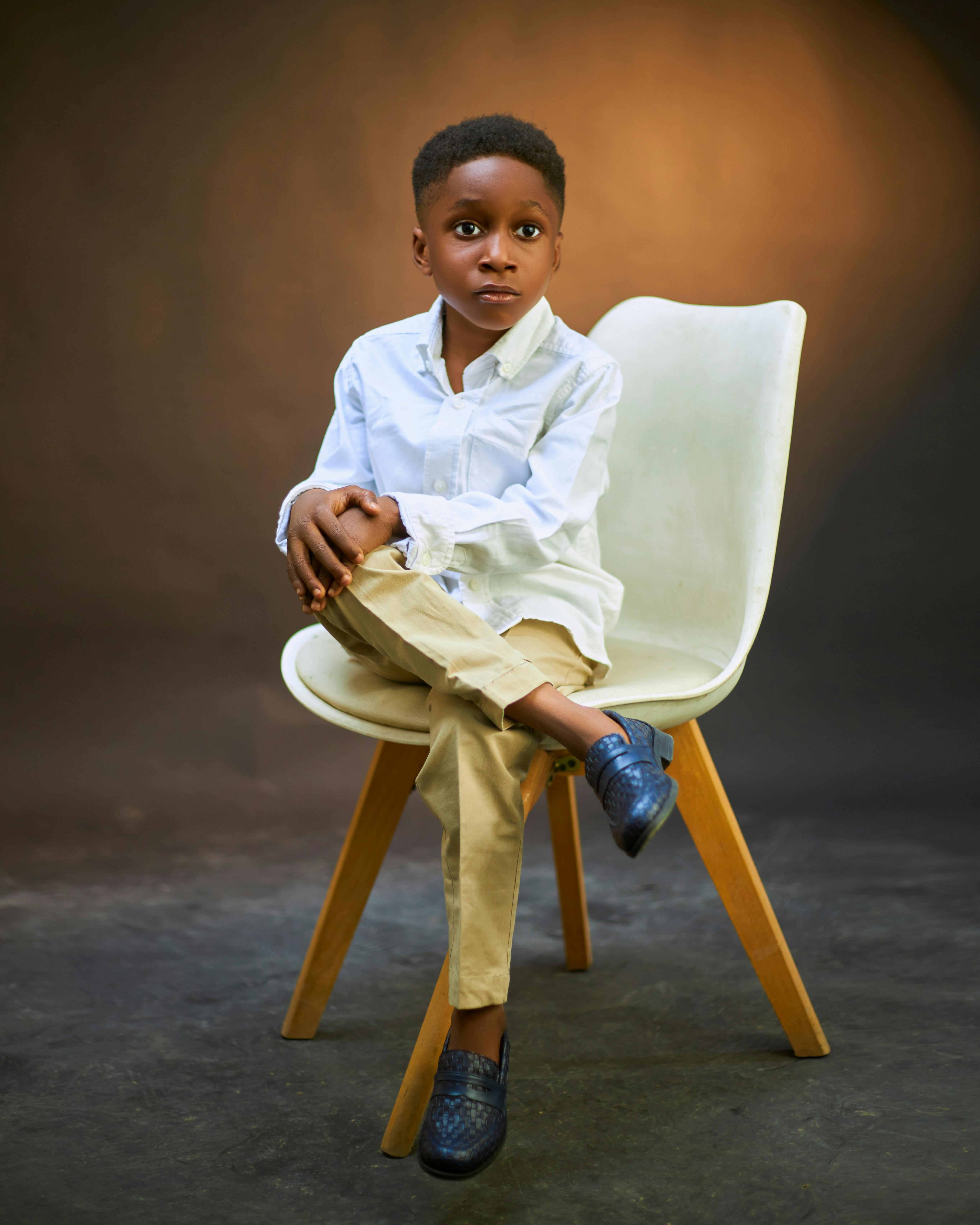Boy Holding Brown Wooden Chair · Free Stock Photo