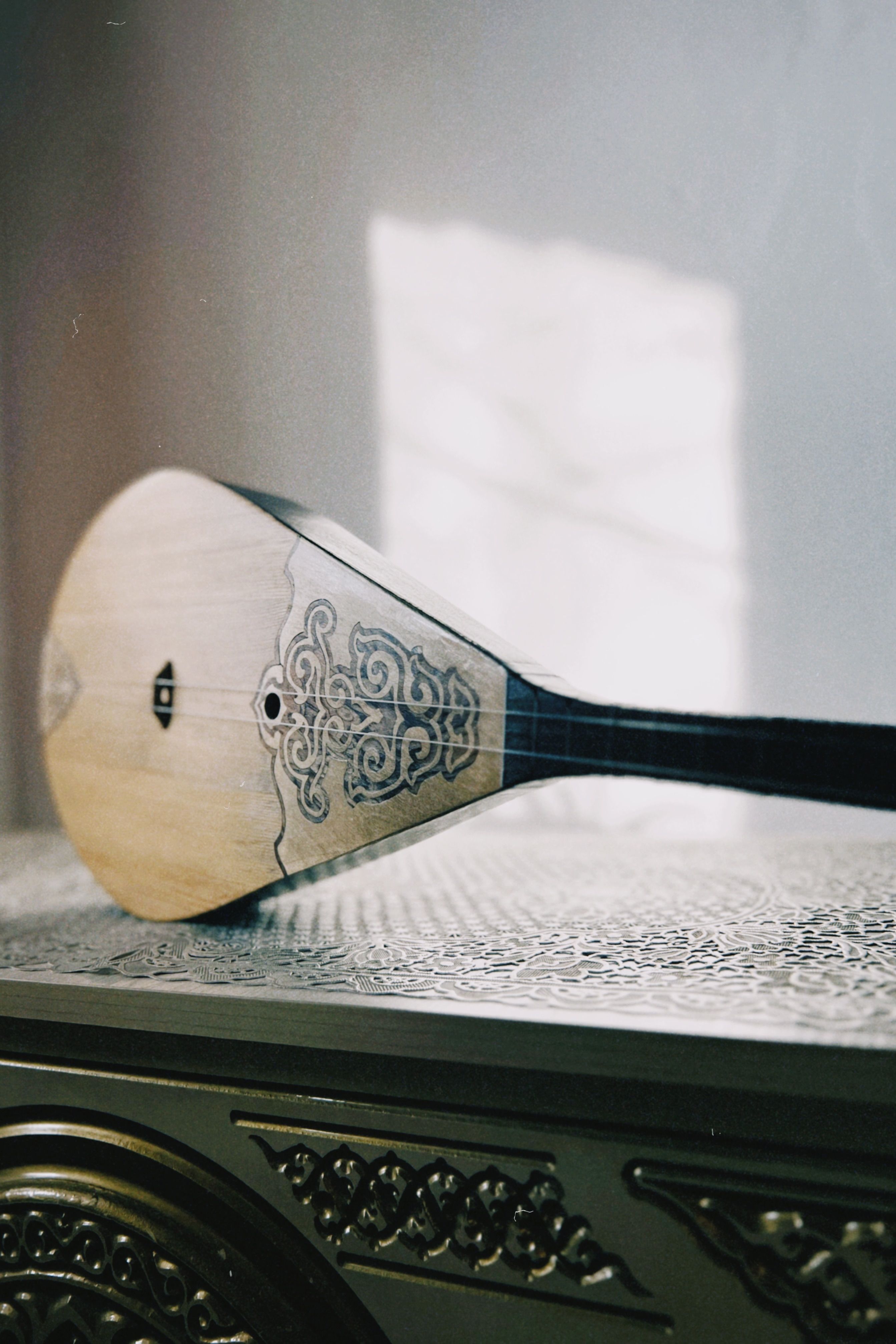 Traditional Kazakh Dombra on Ornate Surface · Free Stock Photo