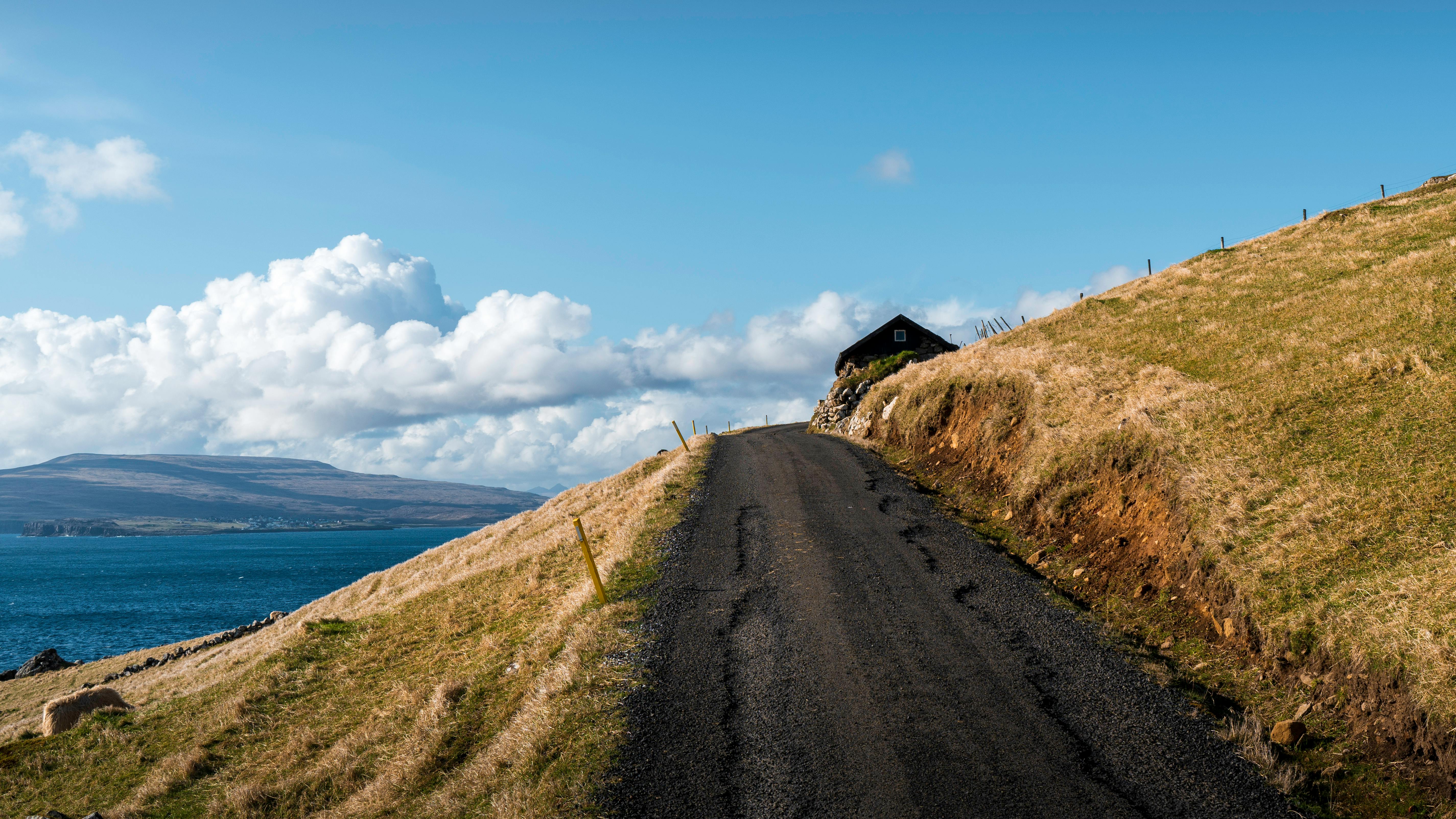 Scenic Faroe Islands Dirt Road with Sea View · Free Stock Photo
