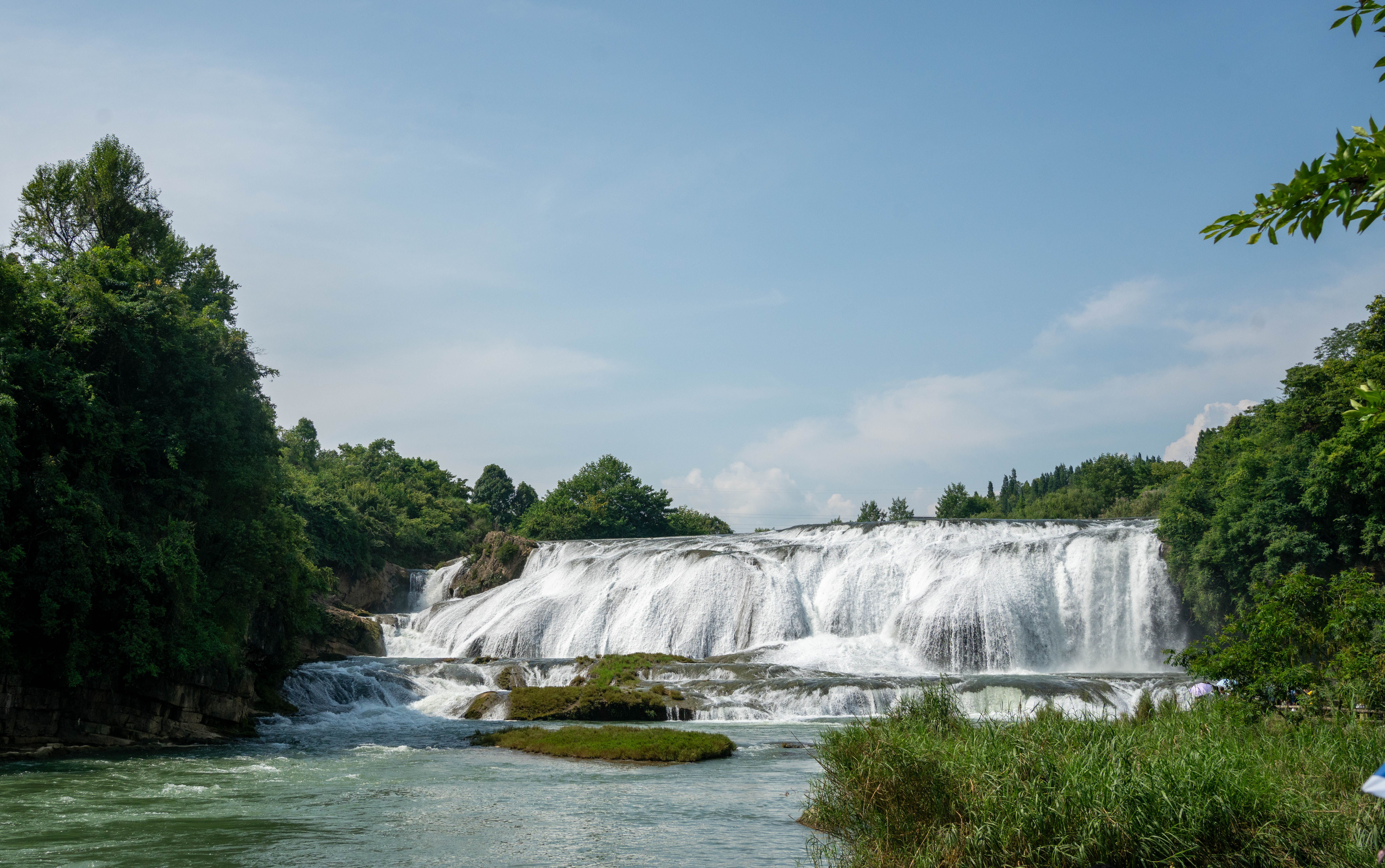 Beautiful Asian Waterfall in Lush Greenery · Free Stock Photo