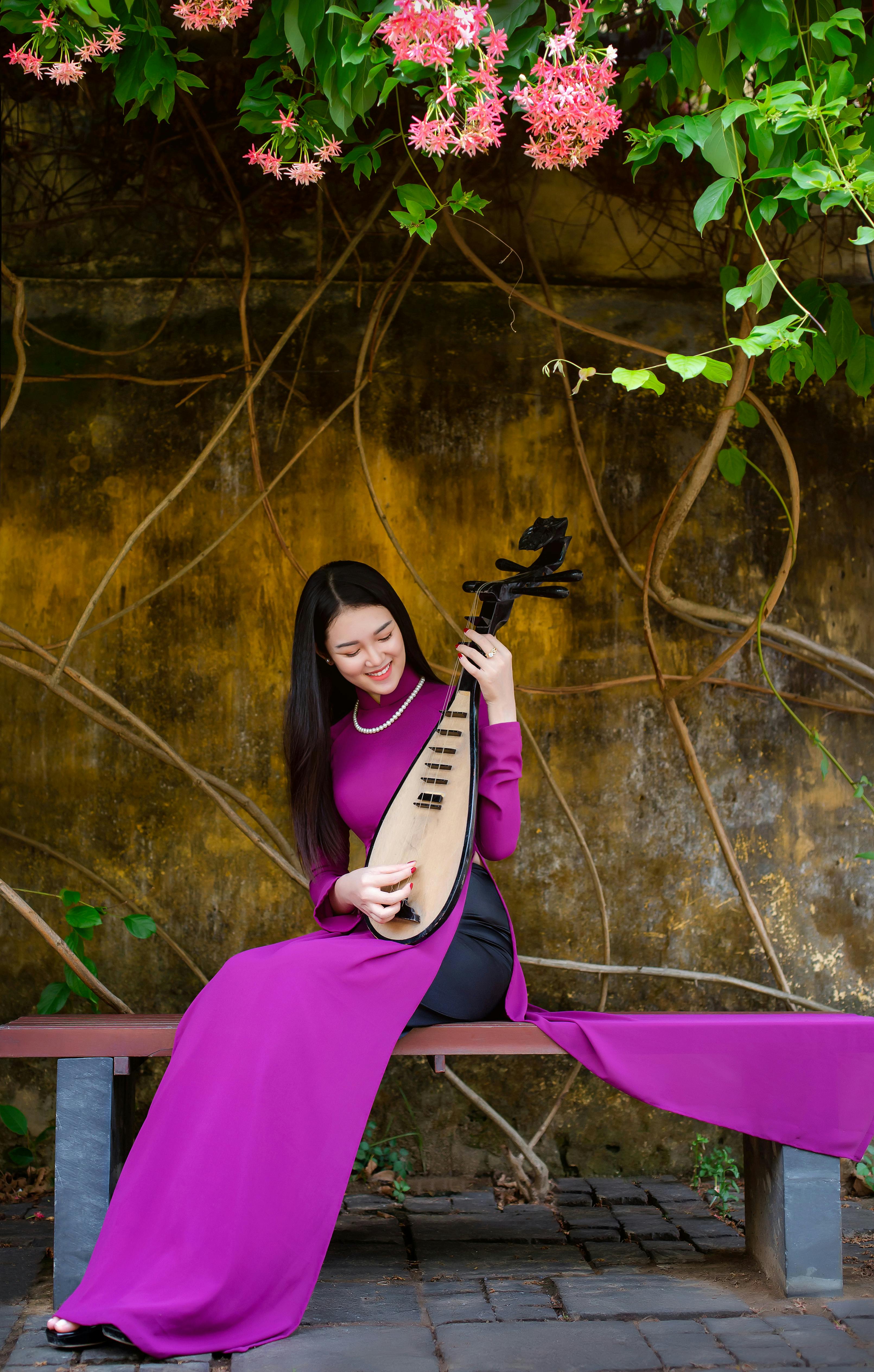 Vietnamese Woman Playing Traditional String Instrument · Free Stock Photo