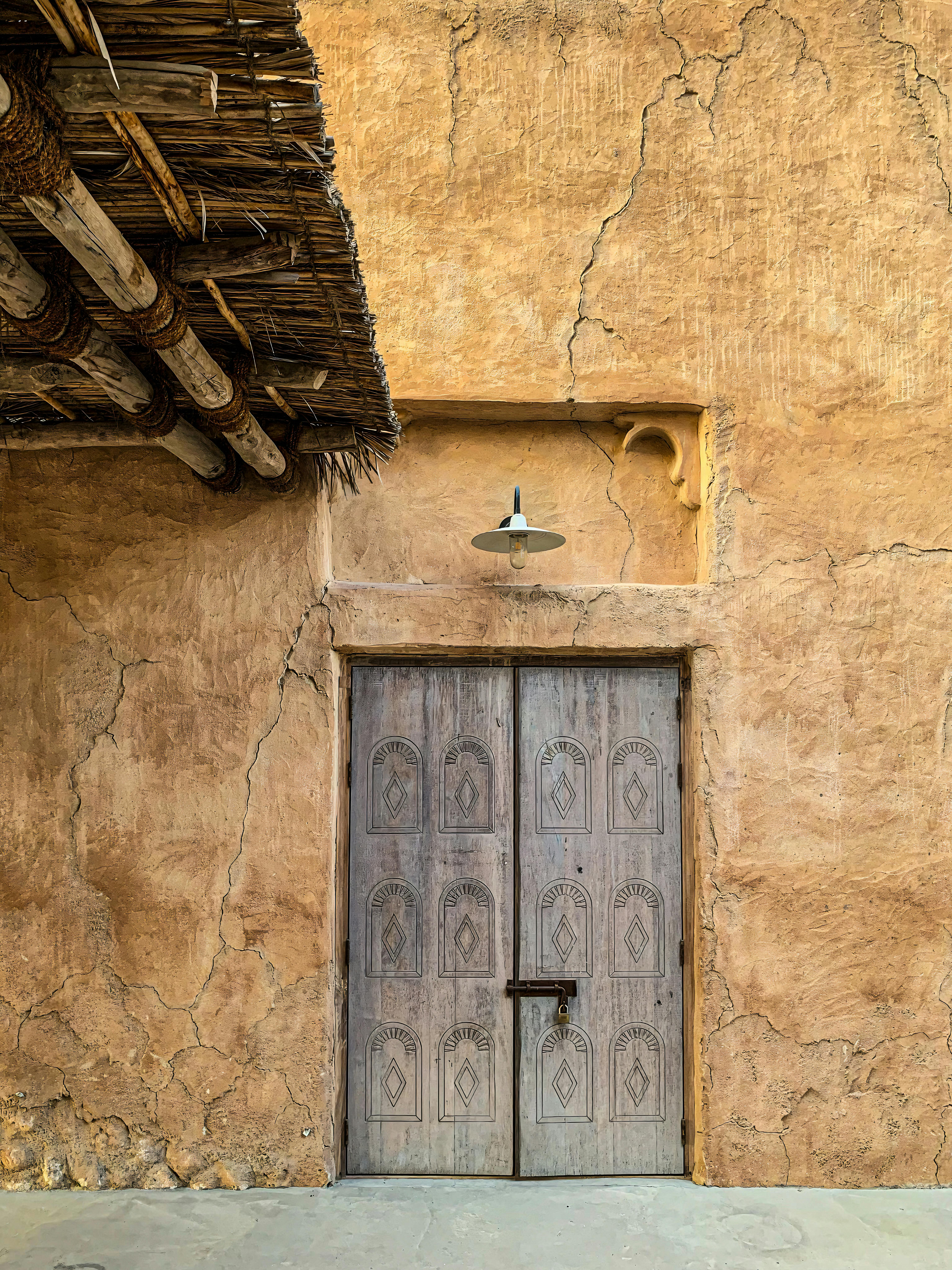 Ancient Wooden Door in Rustic Adobe Building · Free Stock Photo