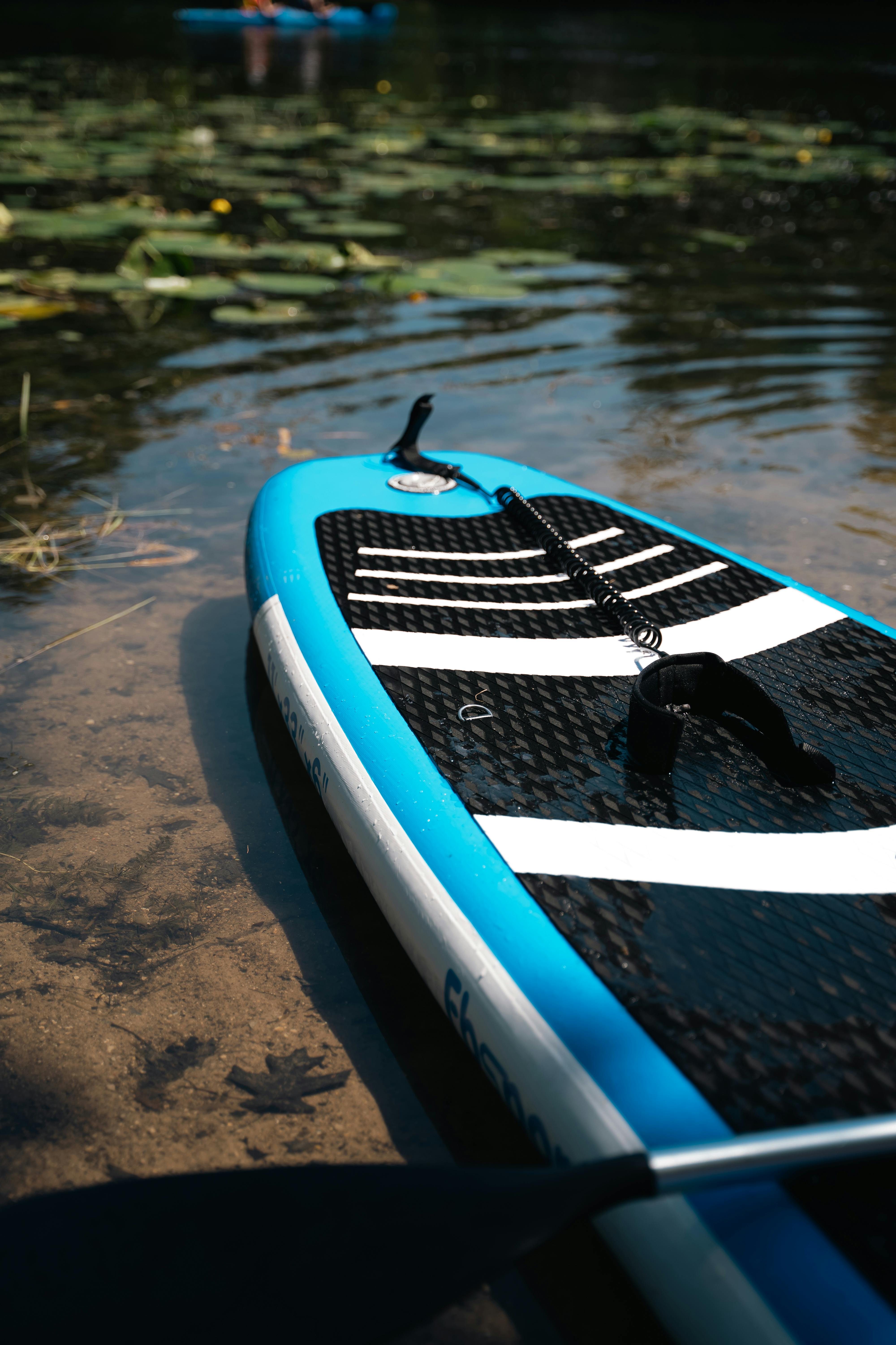 Close-up of a Blue Paddleboard on a Calm Lake · Free Stock Photo