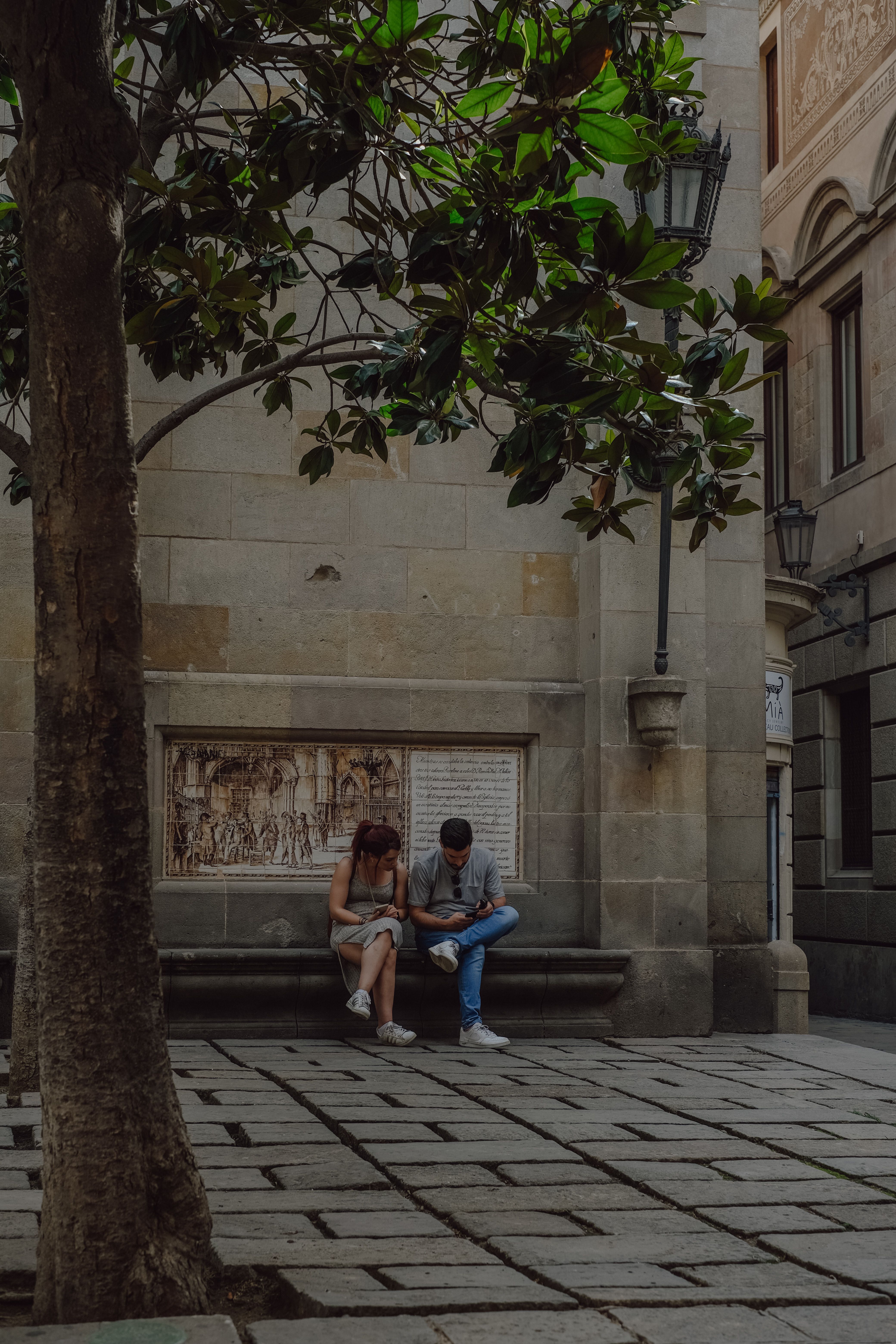 Young Couple Enjoying Urban Rest on Bench · Free Stock Photo