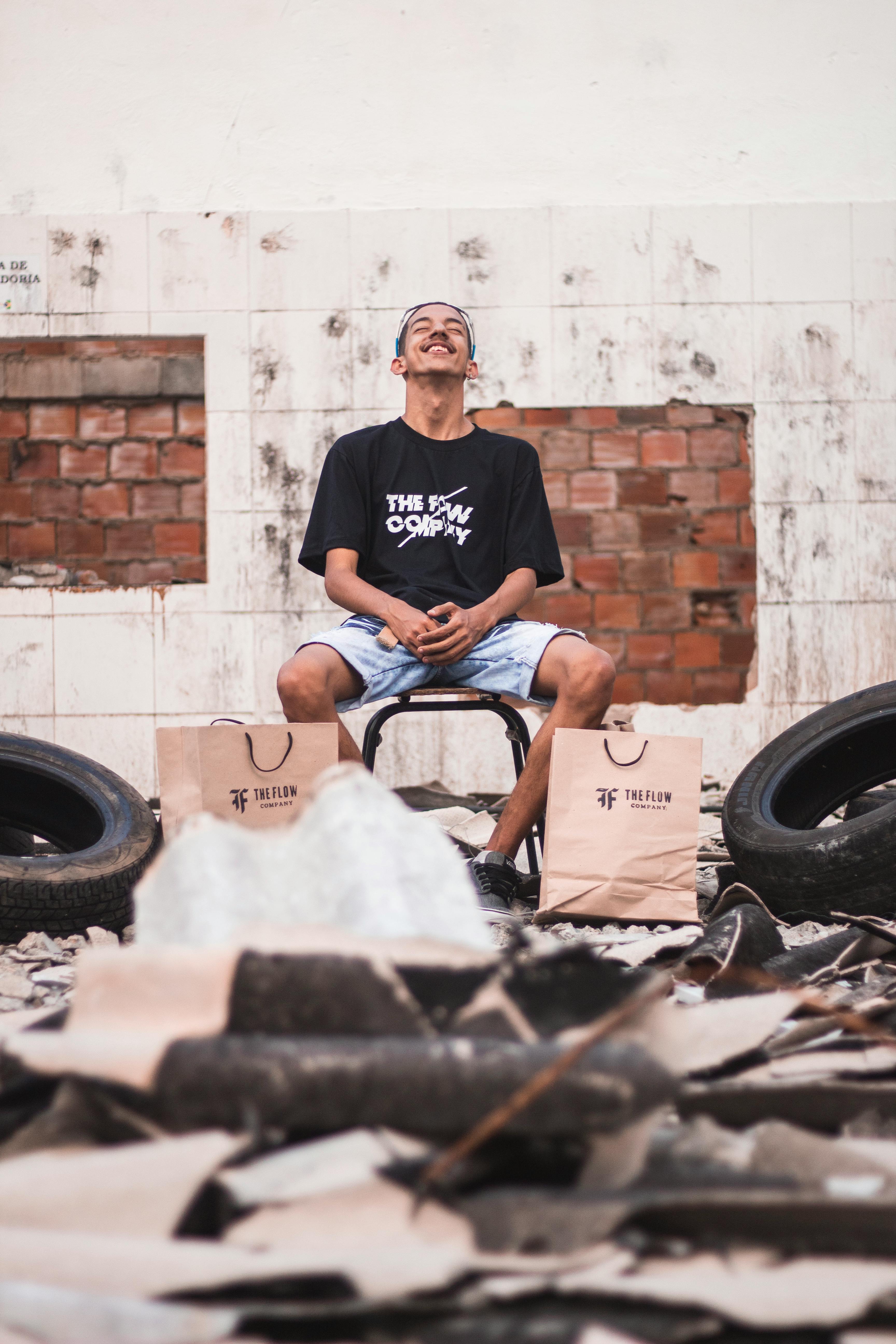Man Sitting On Chair While Looking Up · Free Stock Photo