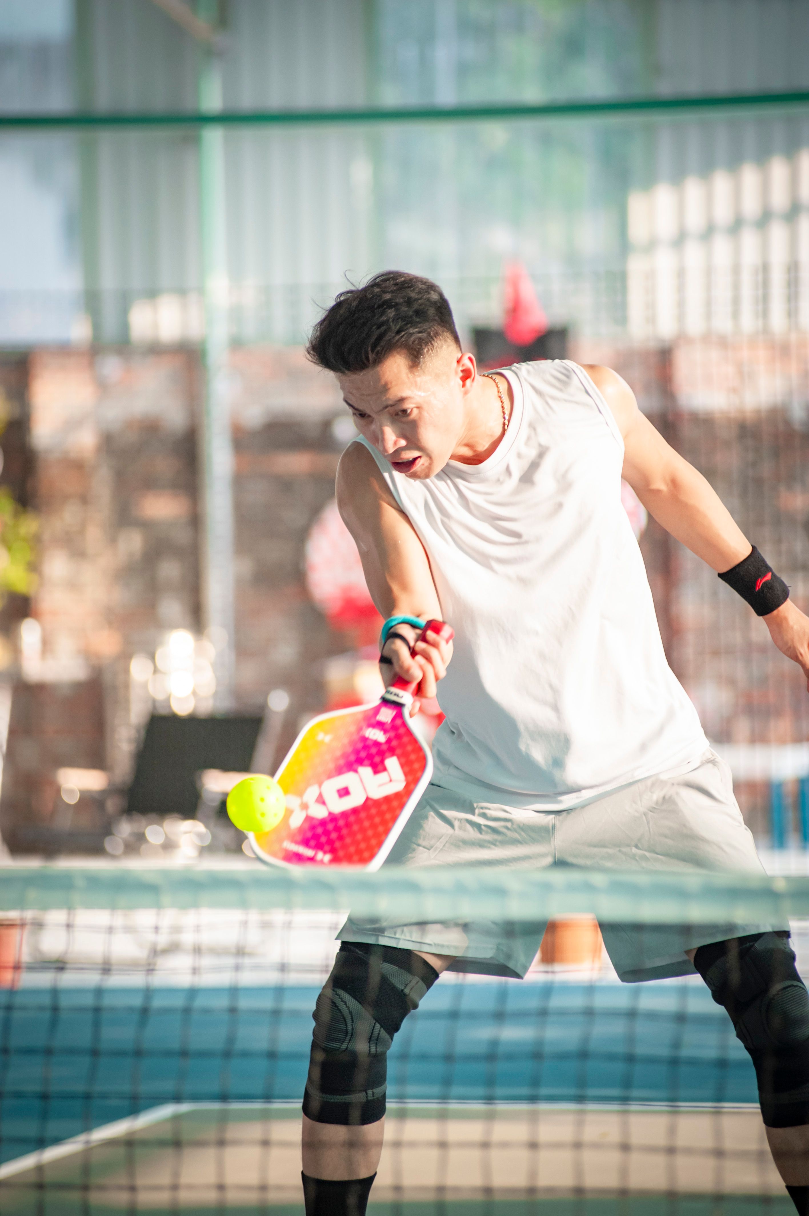 Young Man Playing Pickleball in Hanoi Court · Free Stock Photo