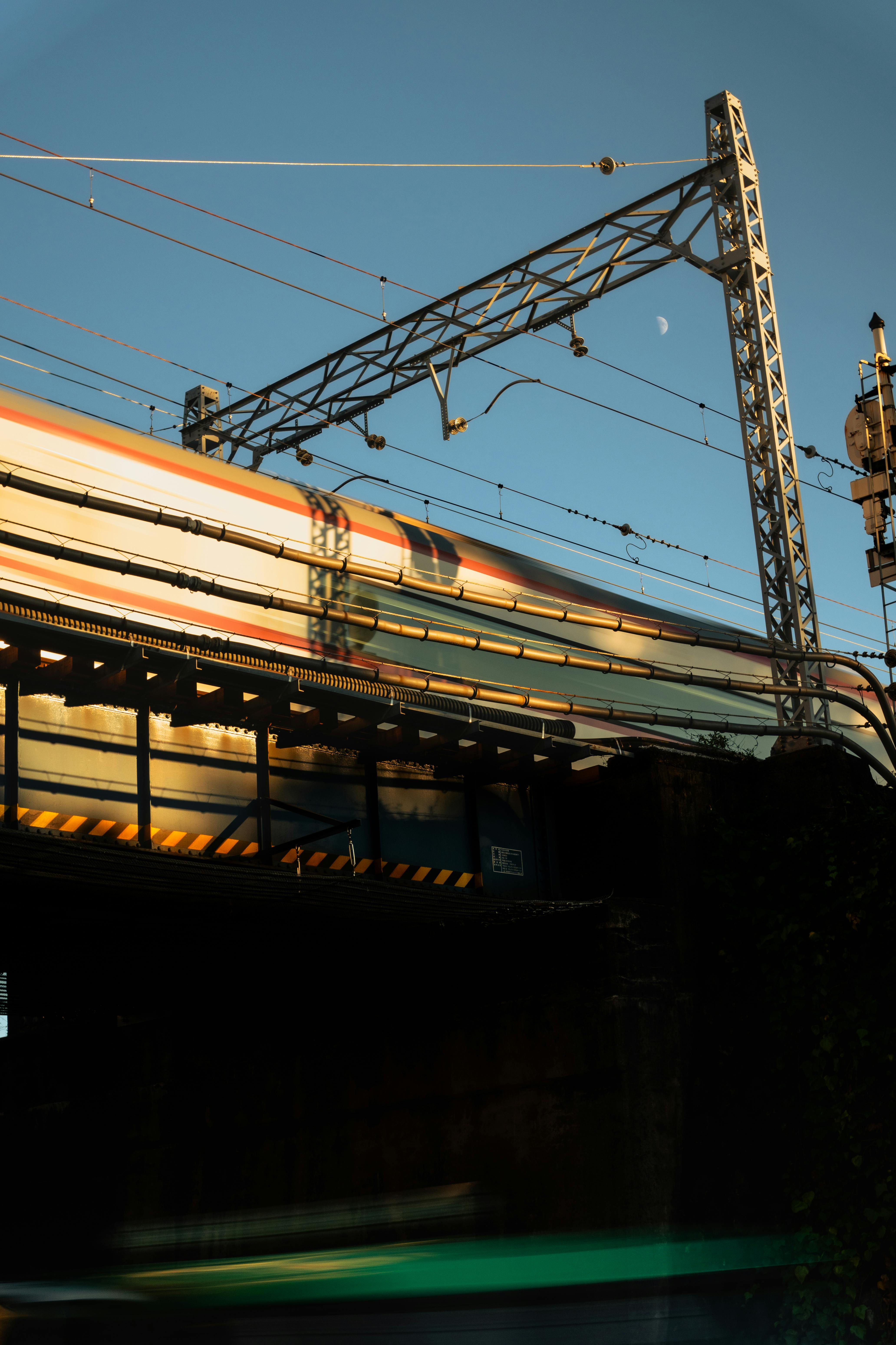 High-Speed Train Passing Steel Overpass · Free Stock Photo