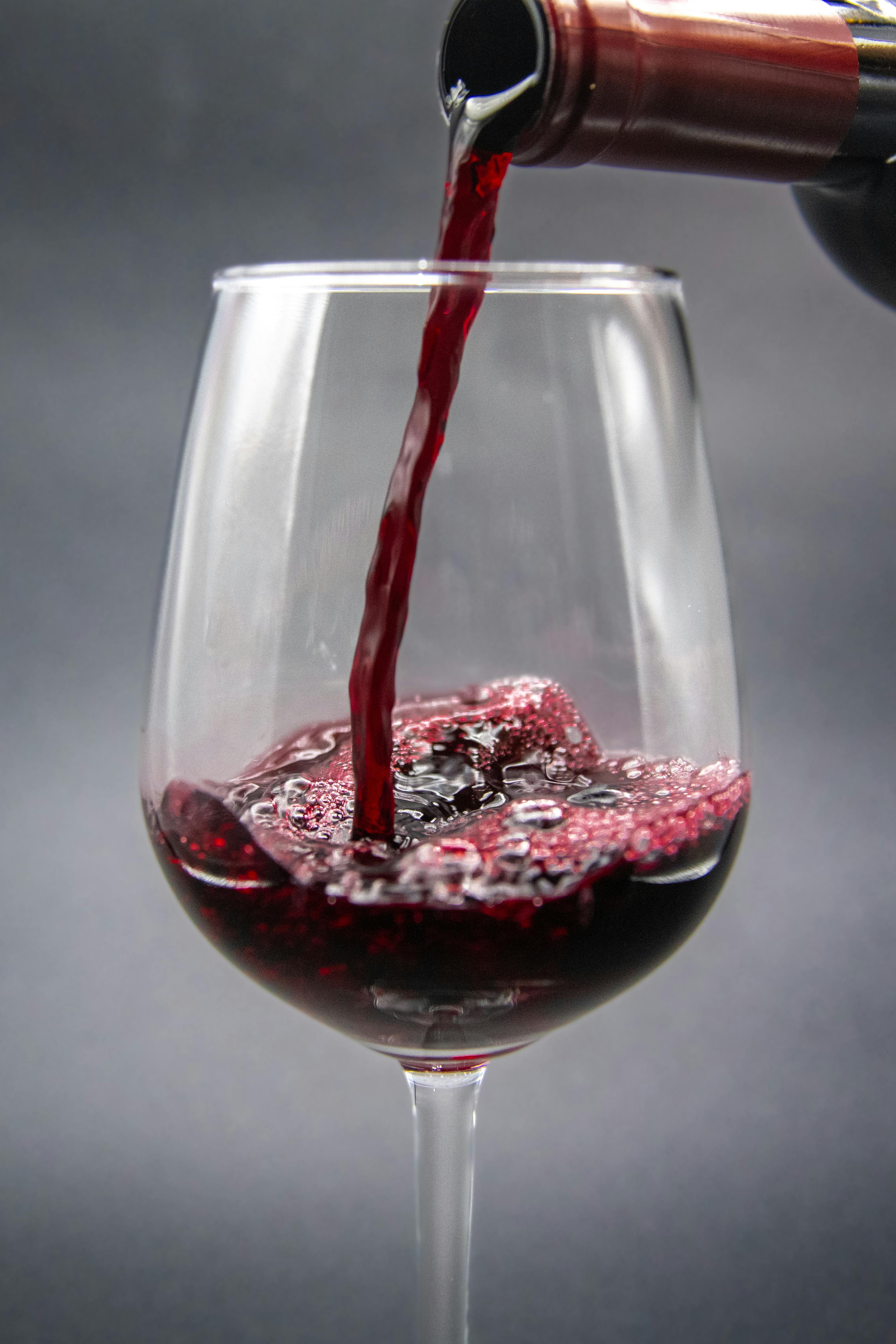 Pouring Red Wine into a Glass - Close-Up · Free Stock Photo