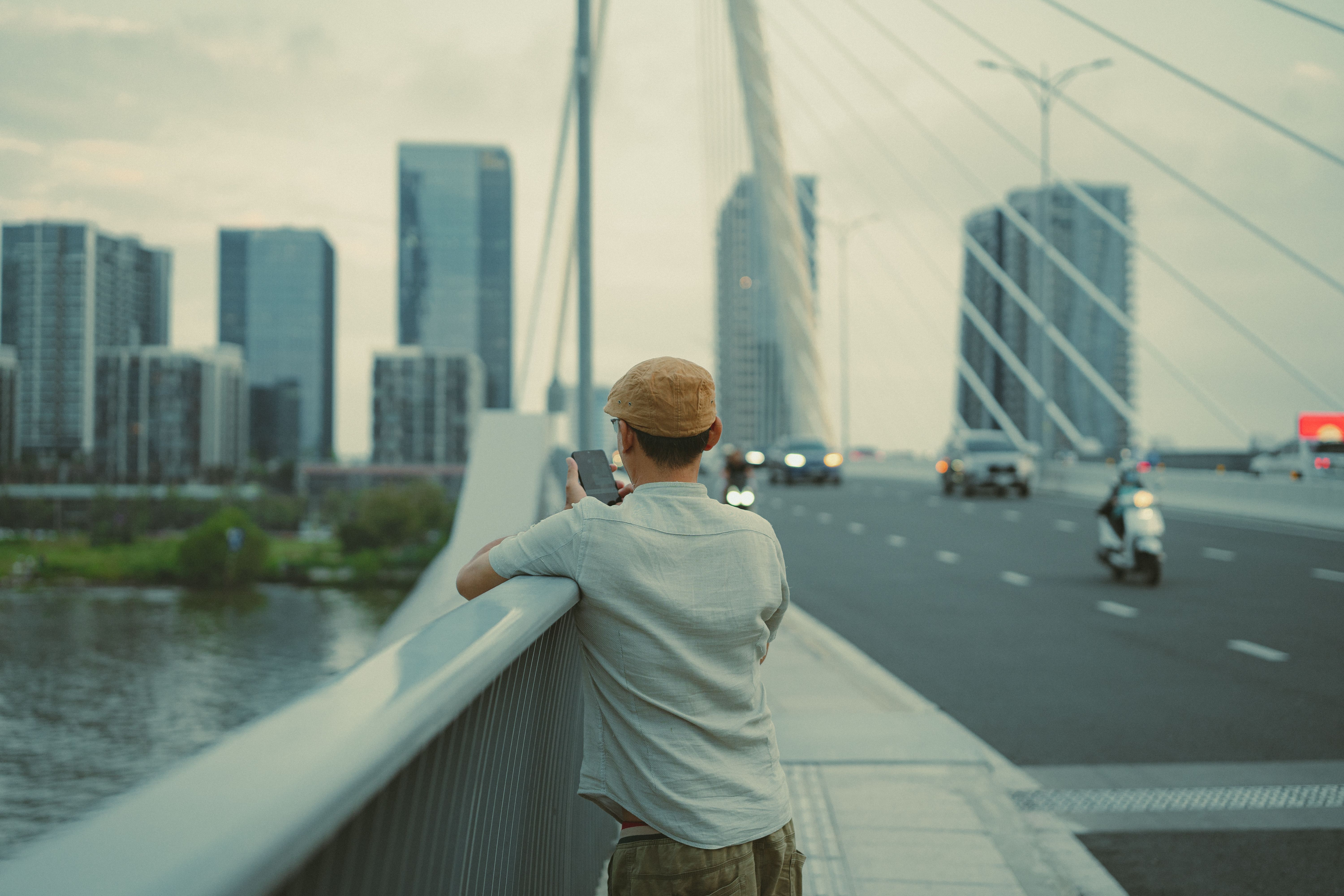 Rear View of Man Photographing Cityscape · Free Stock Photo