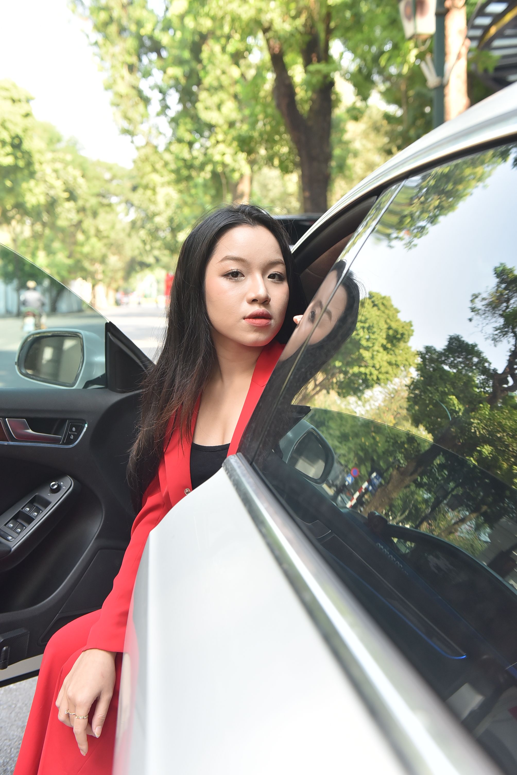 Confident Woman in Red Suit Exiting Car · Free Stock Photo