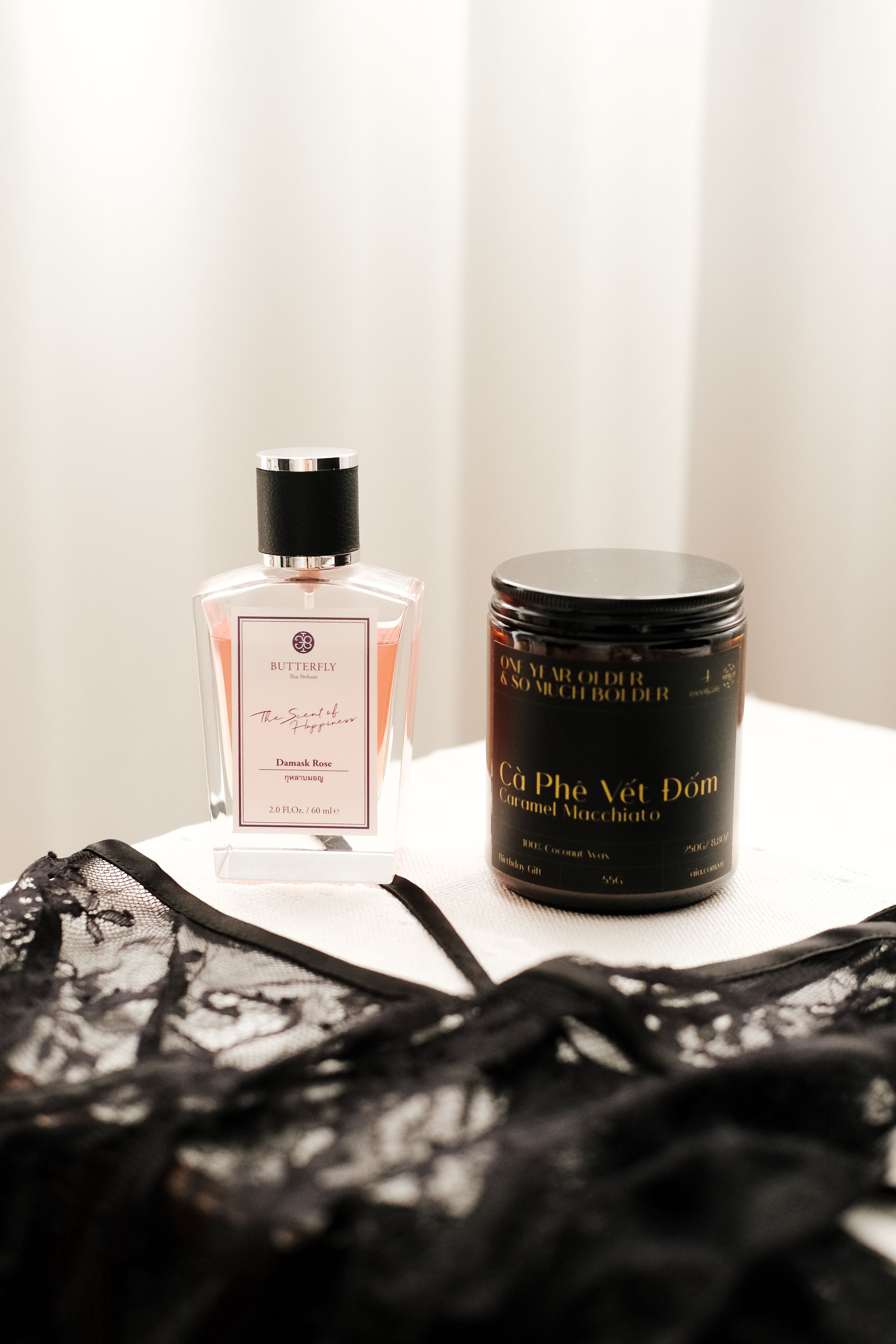 Elegant Perfume and Coffee Display with Black Lace · Free Stock Photo