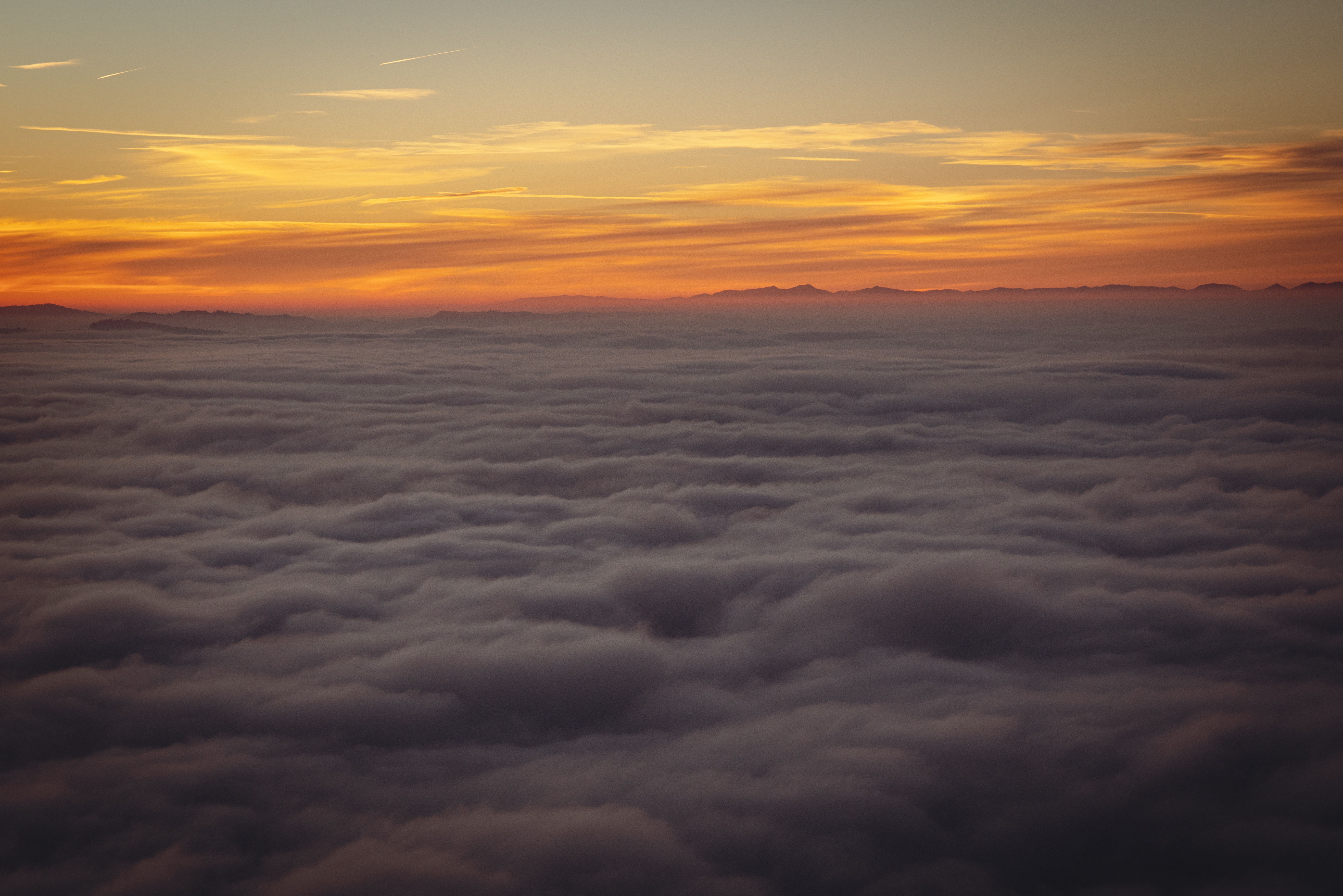 Stunning Aerial View of Sunset Above the Clouds · Free Stock Photo